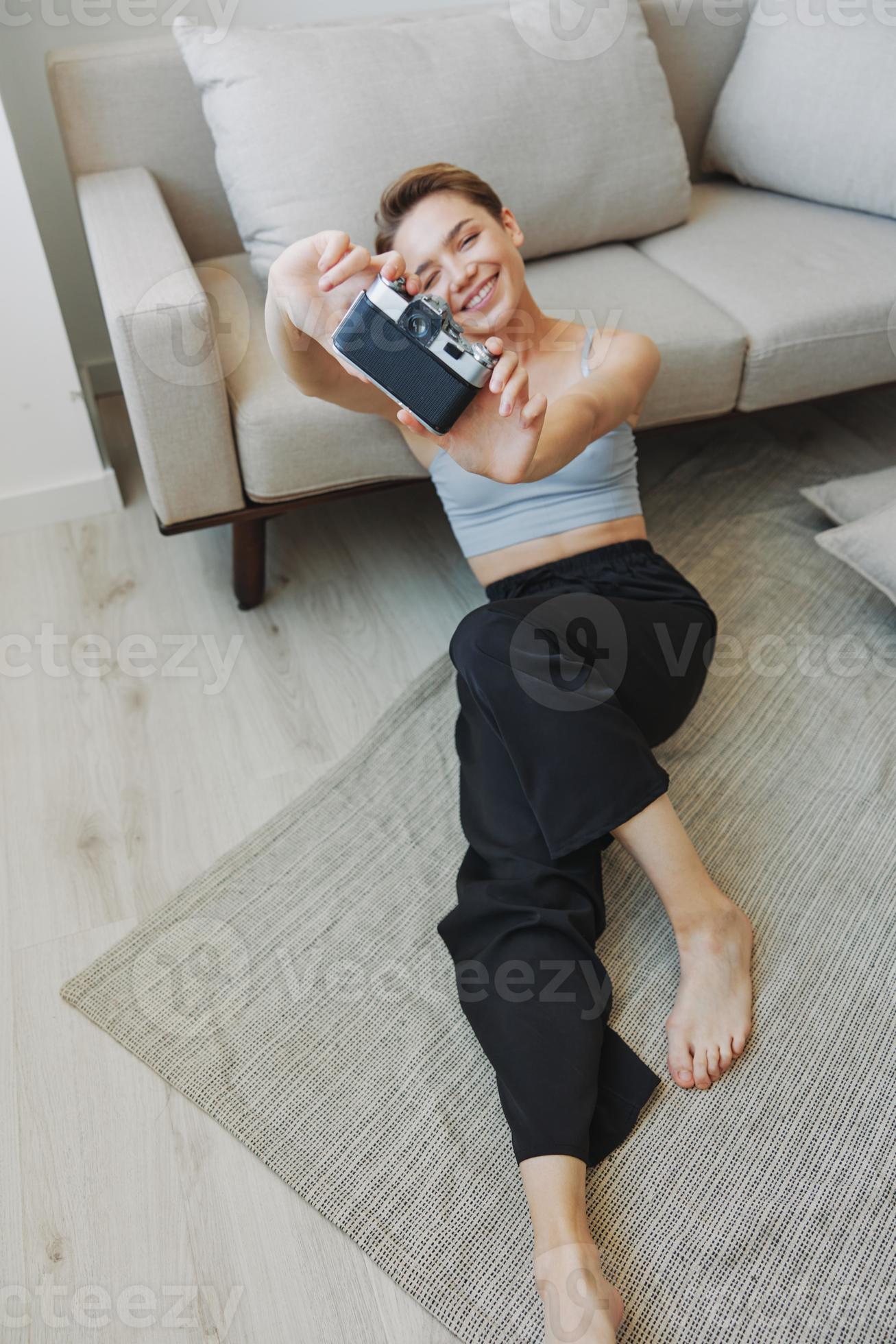 Happy smile woman holding an old camera and taking pictures of herself as a weekend photographer ...