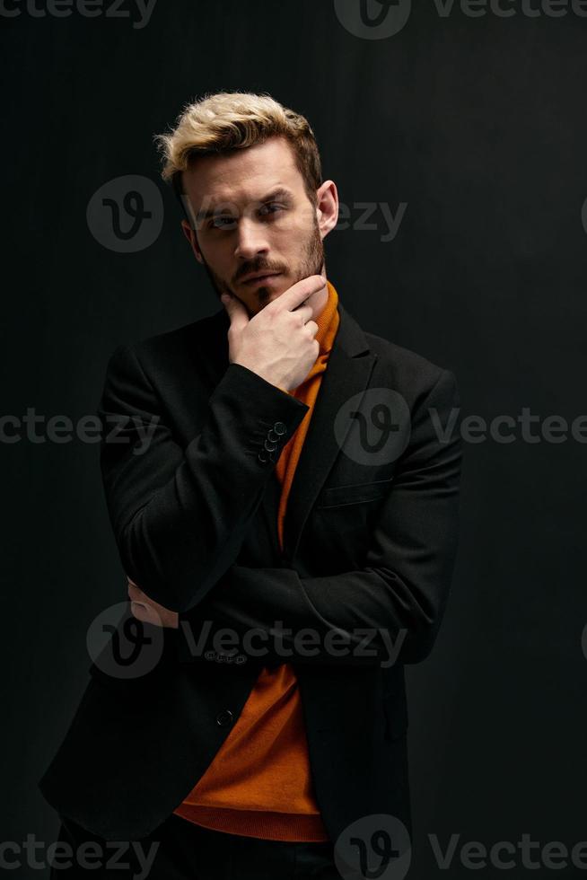Gentleman in suit holds his hand near the face hairstyle model dark ... Gentleman in suit holds his hand near the face hairstyle model dark ...