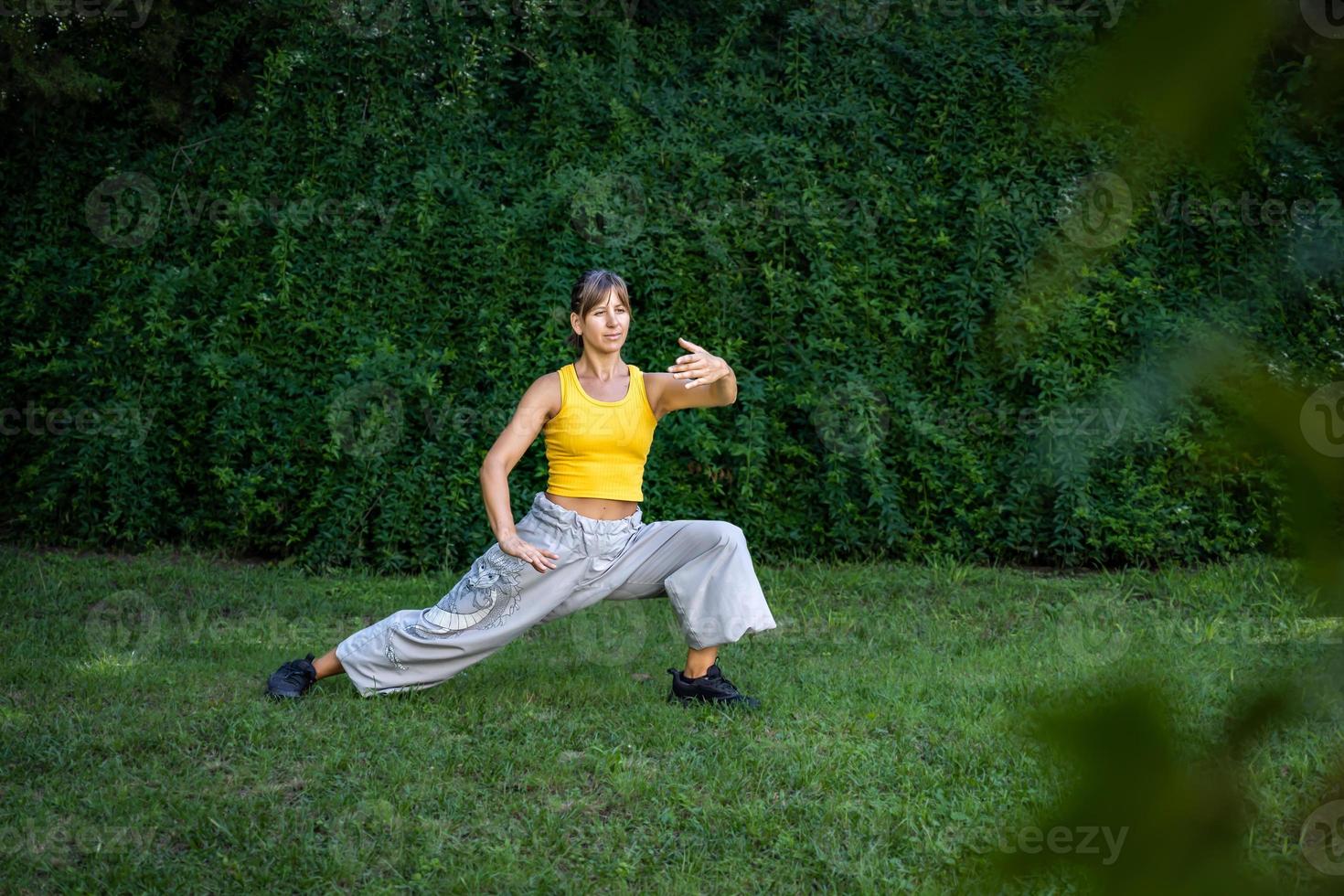 A Woman Practices Tai Chi In A Park Practicing Outdoors Provides A Calm And Relaxing 1124