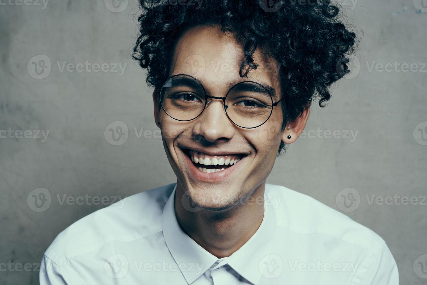happy guy with curly hair and glasses teen model photo studio emotions ...