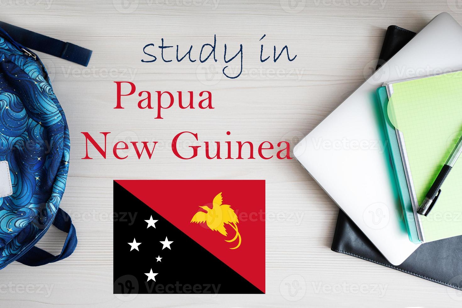 Study in Papua New Guinea. Background with notepad, laptop and backpack ...