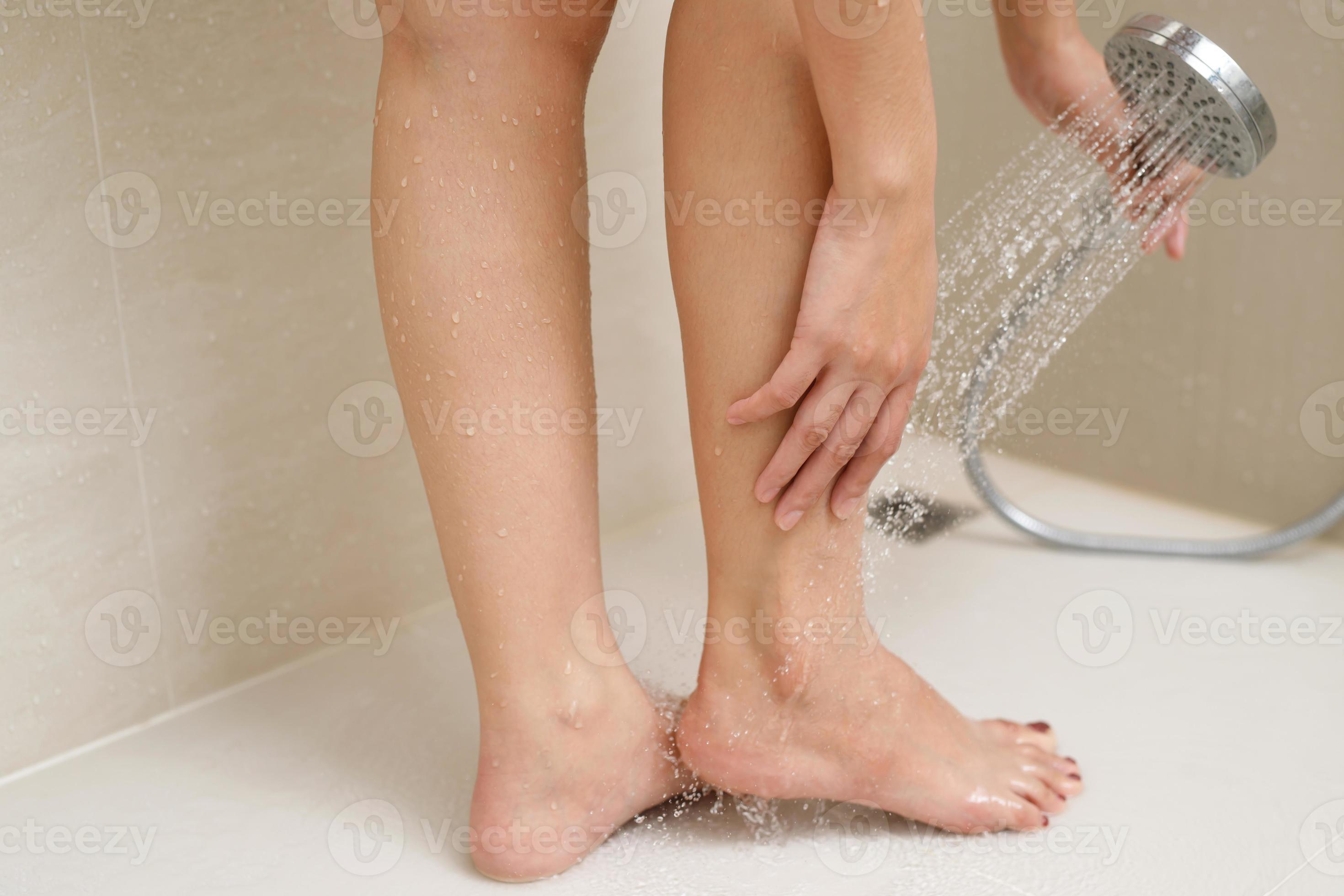 woman using shower to clean feet 22679292 Stock Photo at Vecteezy