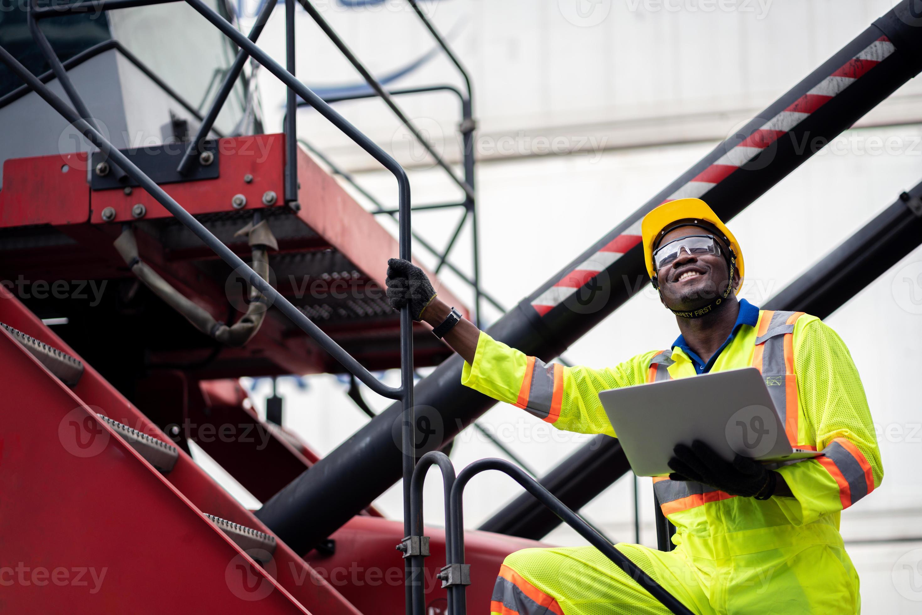 engineer man worker in safety jumpsuit uniform with yellow hardhat and use laptop computer ...
