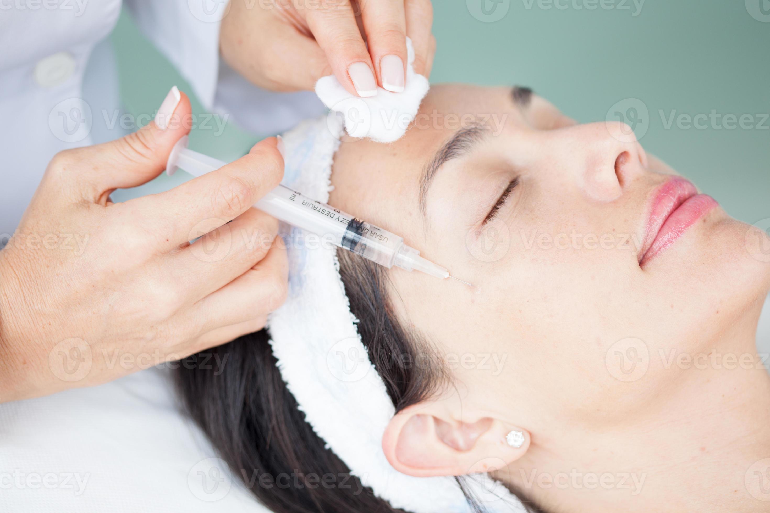 Doctor Applying An Anti Aging Facial Treatment On Young Woman Patient