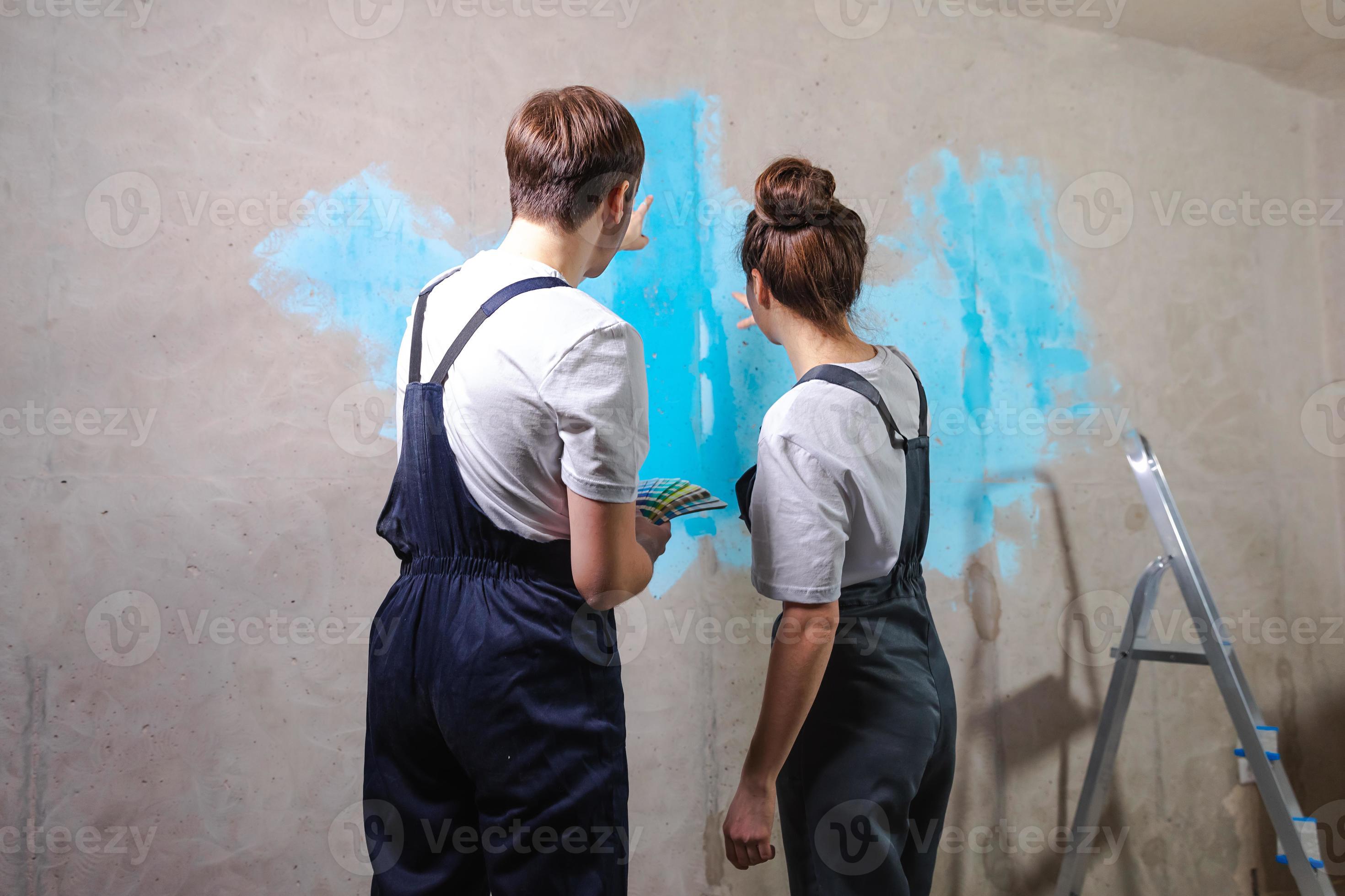 House decoration DIY renovation concept. Happy couple in empty room of ...