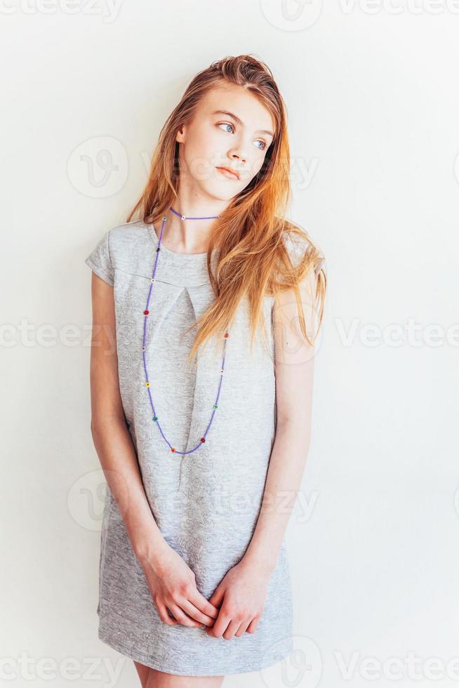Beauty teenage girl. Portrait young teen woman in grey dress against ...