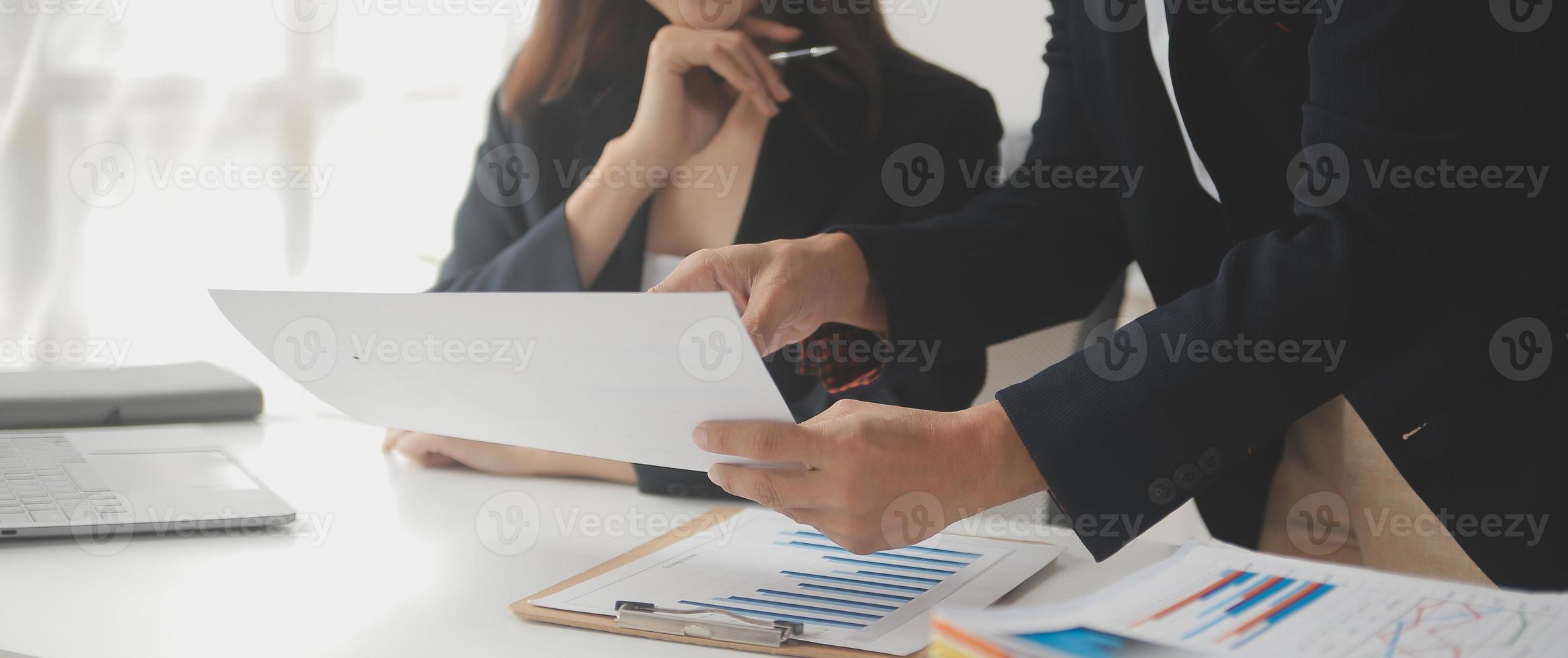 Business professionals. Group of young confident business people analyzing data using computer ...