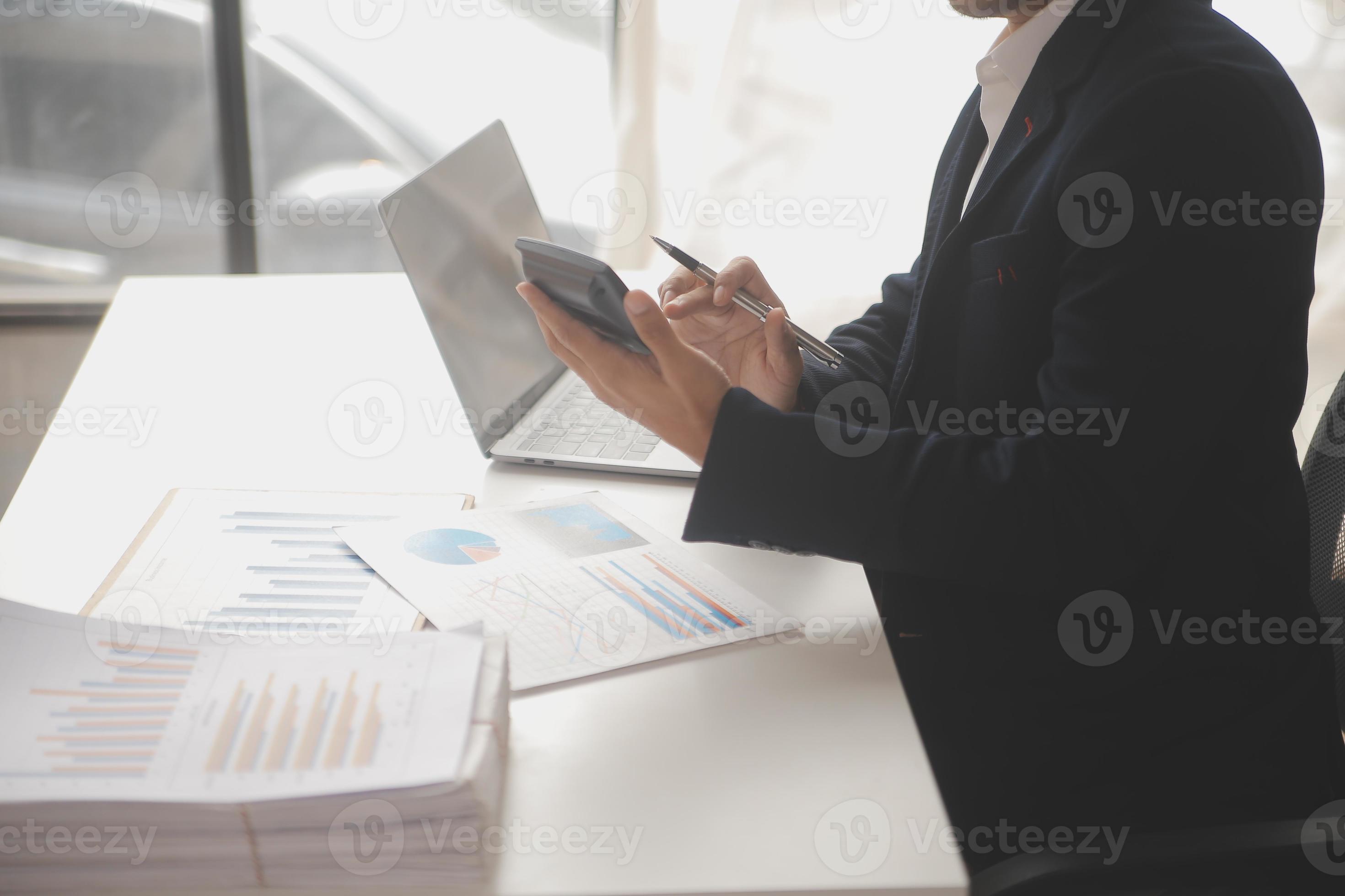 Business professionals. Group of young confident business people analyzing data using computer ...