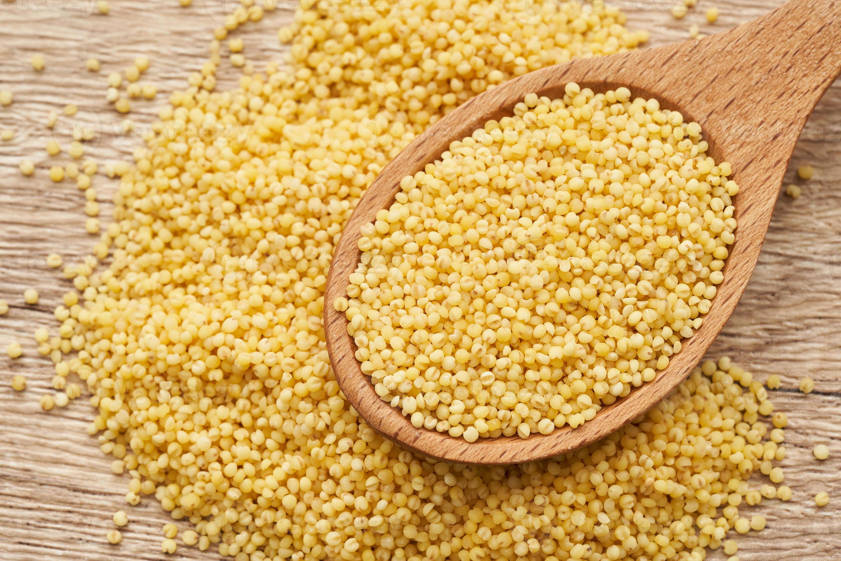 Pile Of Sorghum Or Sorghum Grain Millet Grain Or Millet Seed In Wood Spoon On Wooden Table