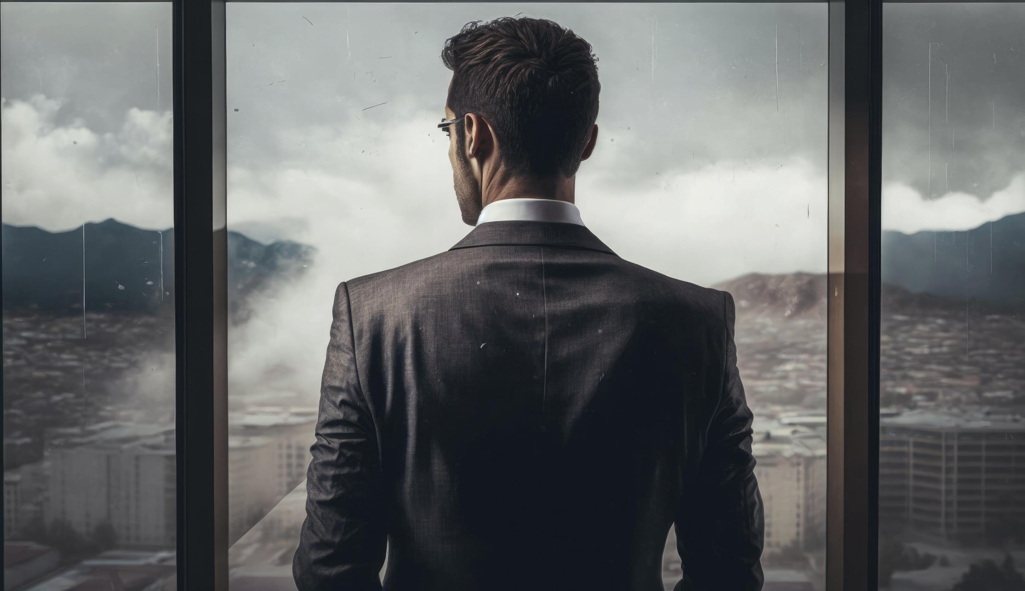 business man looking out through the office balcony seen through glass ...