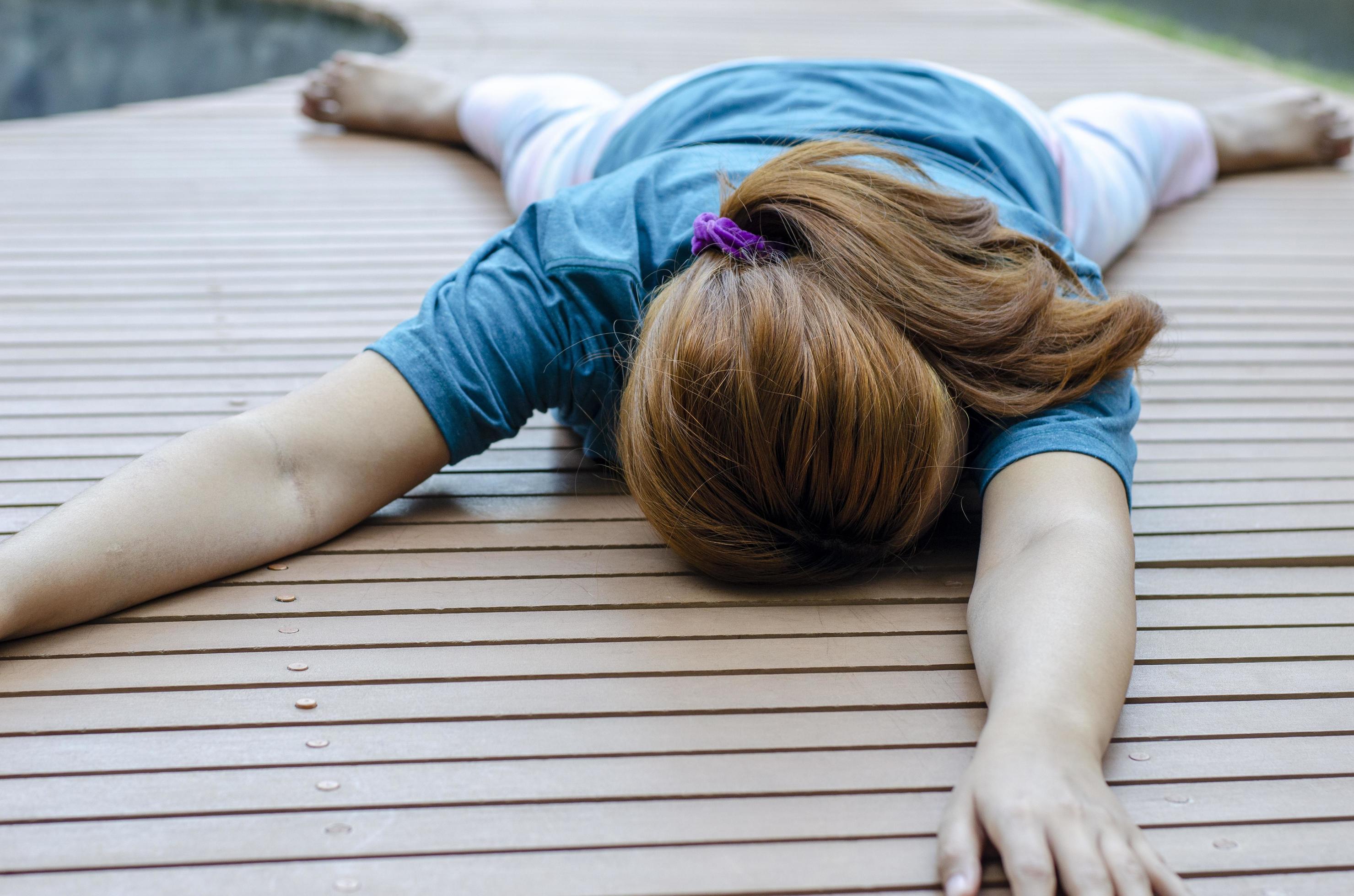 Woman Lying Face Down Fainting Because Of Hot Weather 22995197 Stock