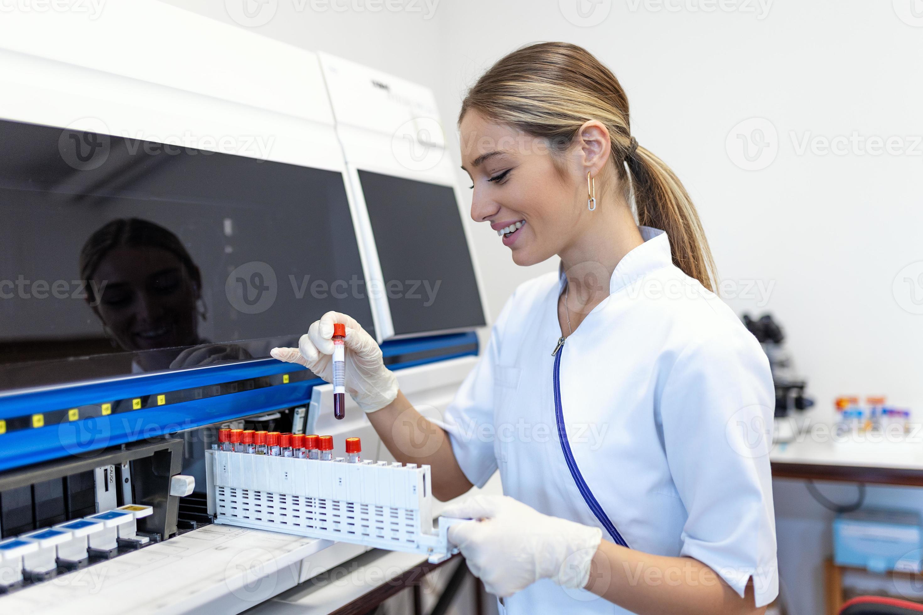 Lab tech loading samples into a chemistry analyzer. female lab tech ...