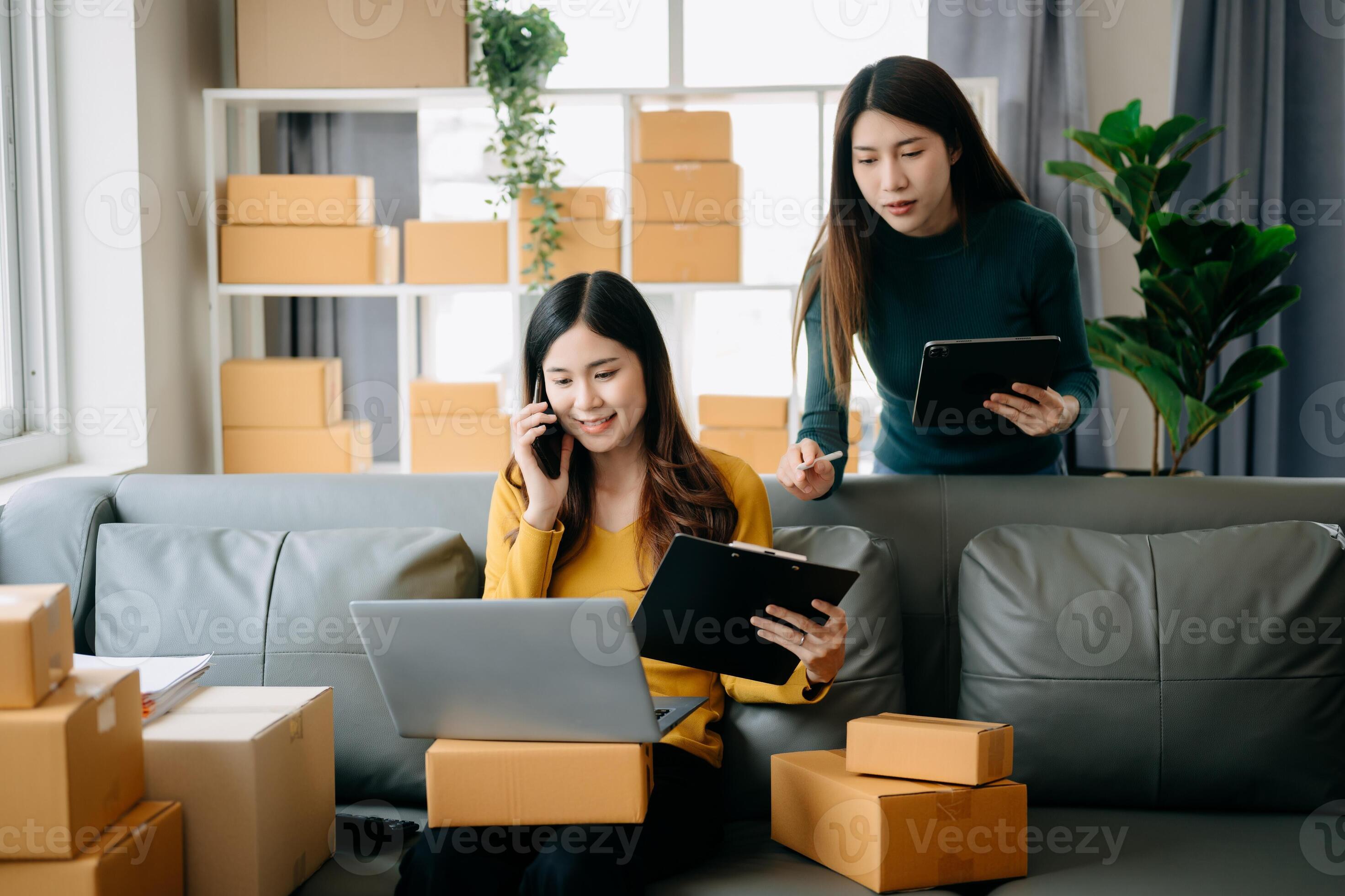 Starting small businesses SME owners, two check online orders Selling products working with boxs ...