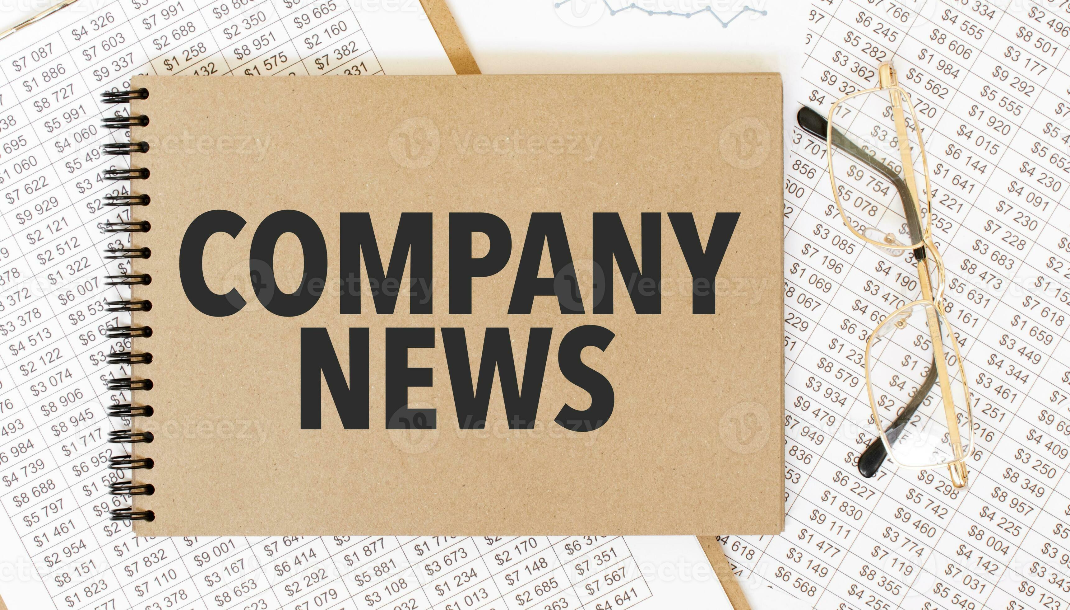 Craft colour notepad with text COMPANY NEWS. Notepad with eyeglasses and text documents ...