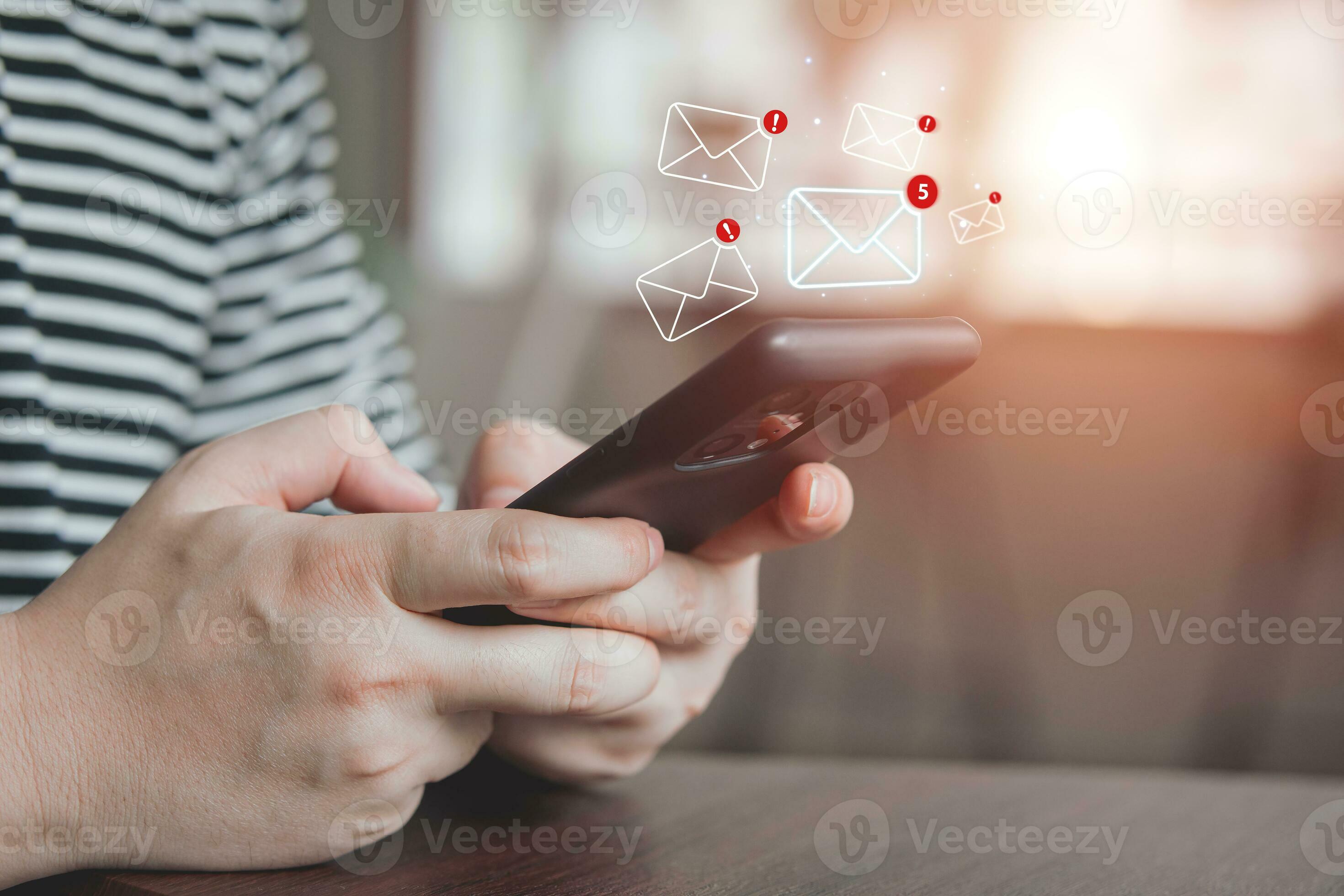 Electronic mail with message notification. Hand pressing smartphone to ...