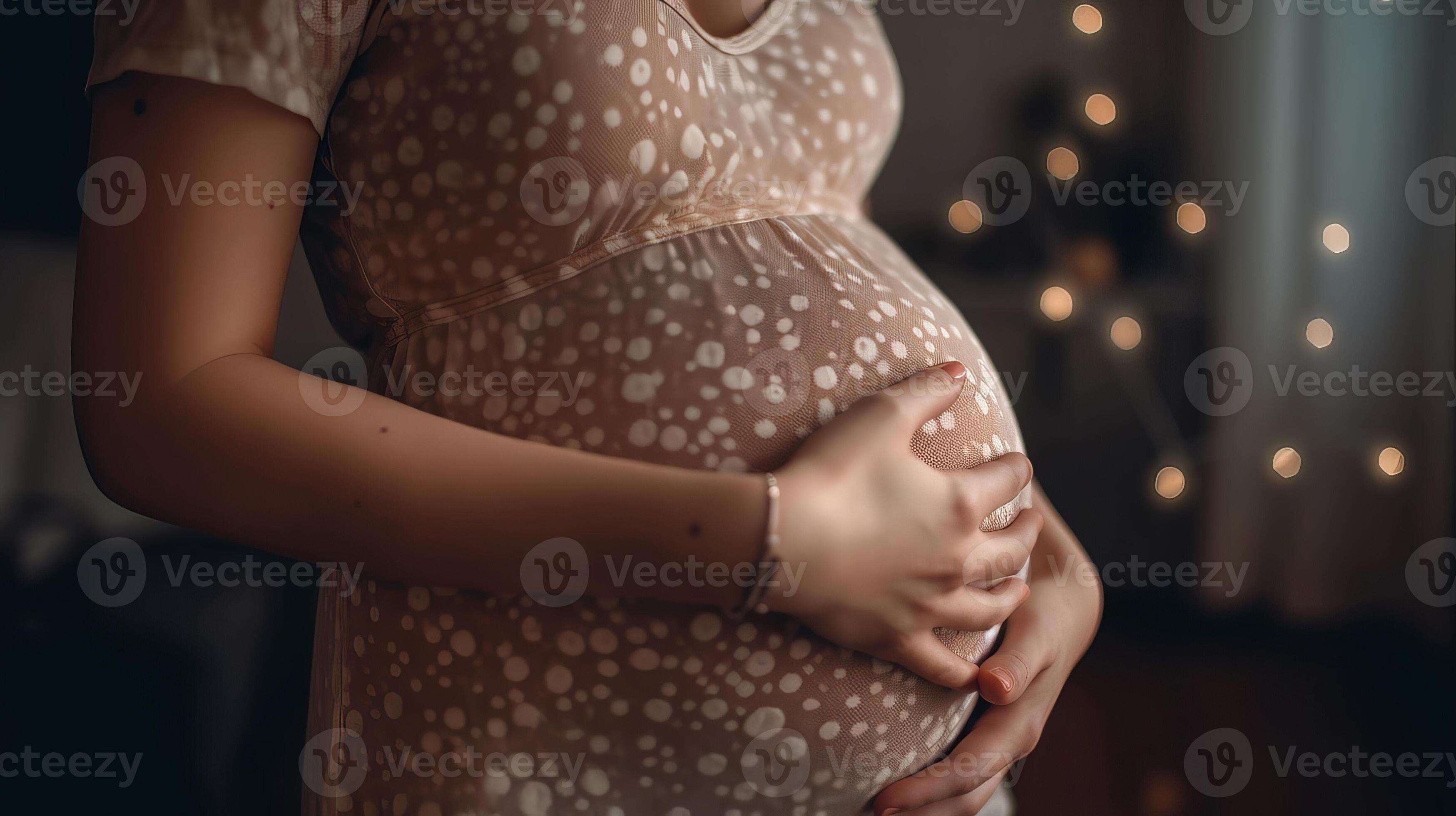 A Pregnant Woman Holds Her Hands On Her Stomach Close Up Center On Her