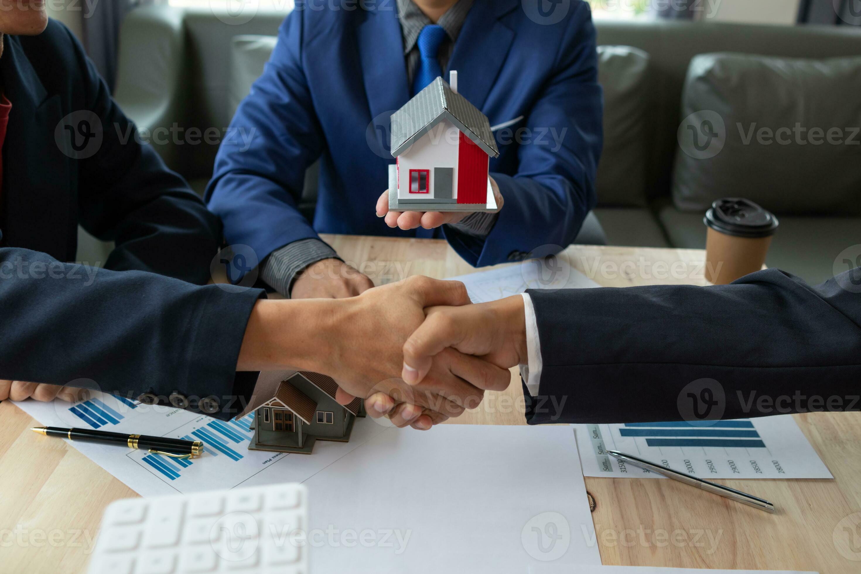 Real estate sales documents and model homes are placed on tables inside real estate sales ...