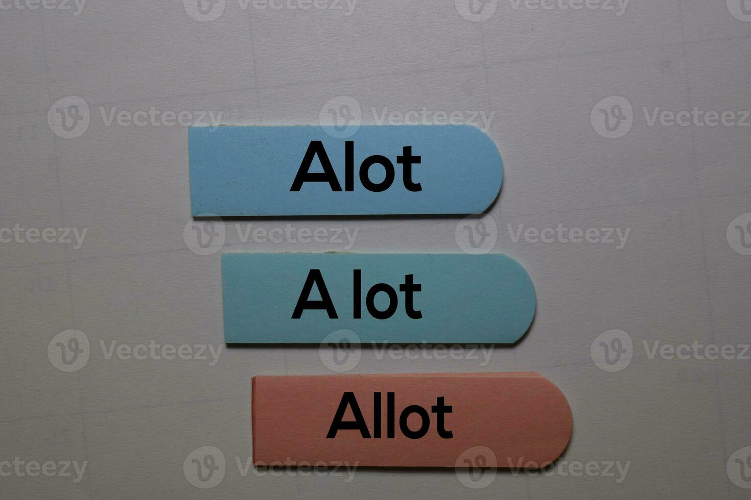 Alot, a lot, Allot write on a sticky note isolated on office desk ...