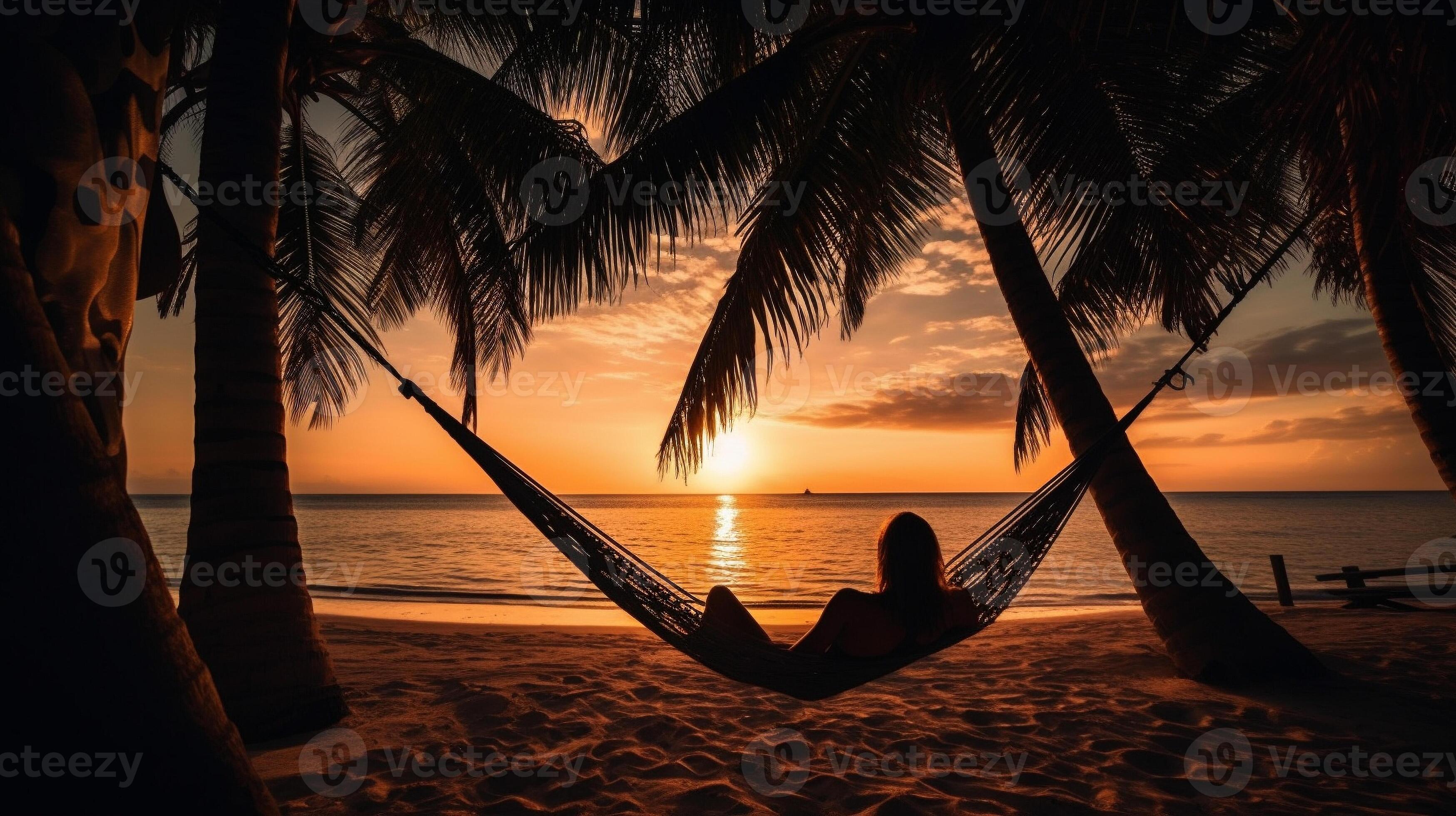 Peaceful Tropical Sunset Scene With Woman Relaxing In A Hammock