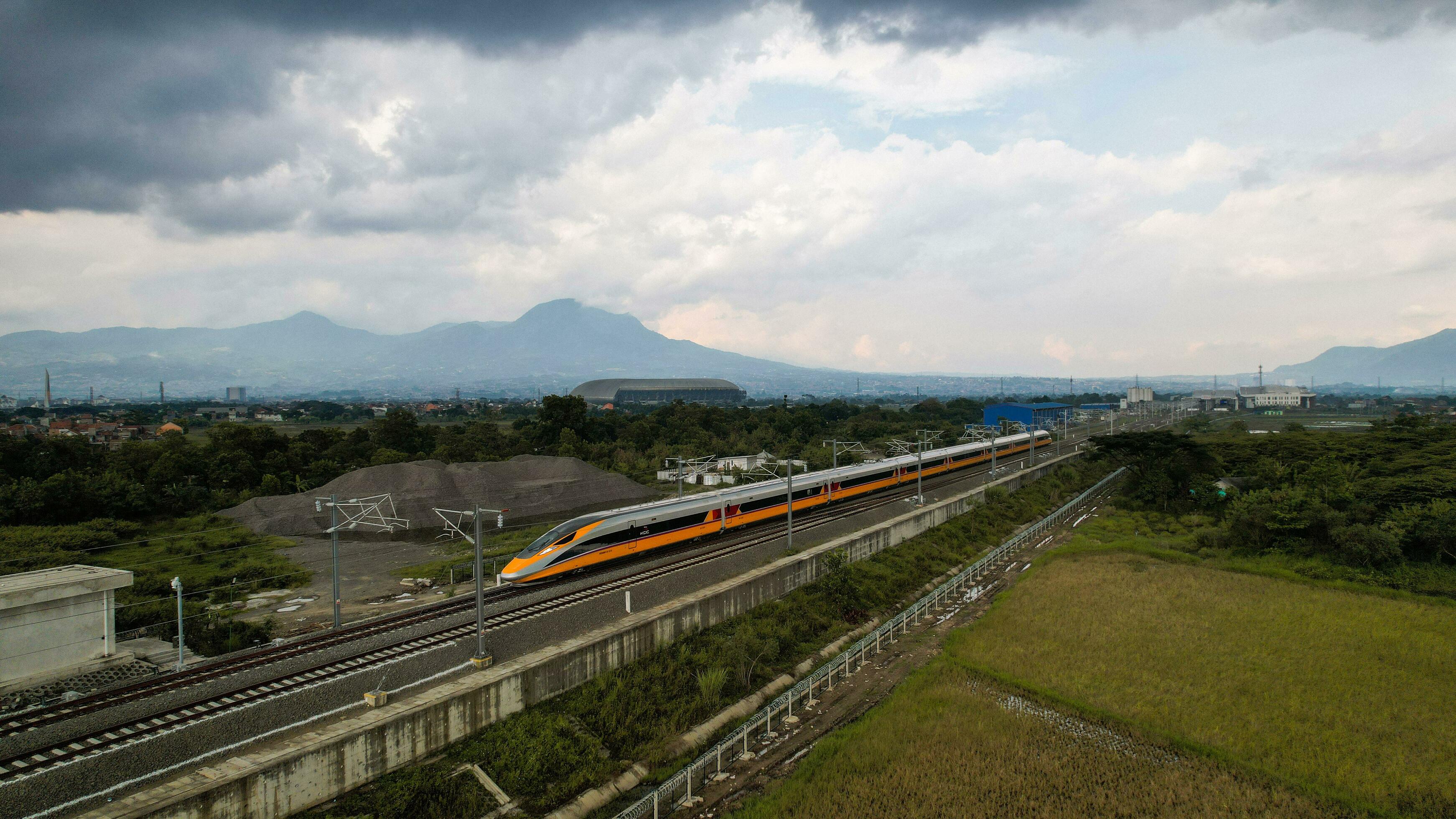 Aerial view of the High speed orange train on the railway station. High Speed Train Jakarta ...