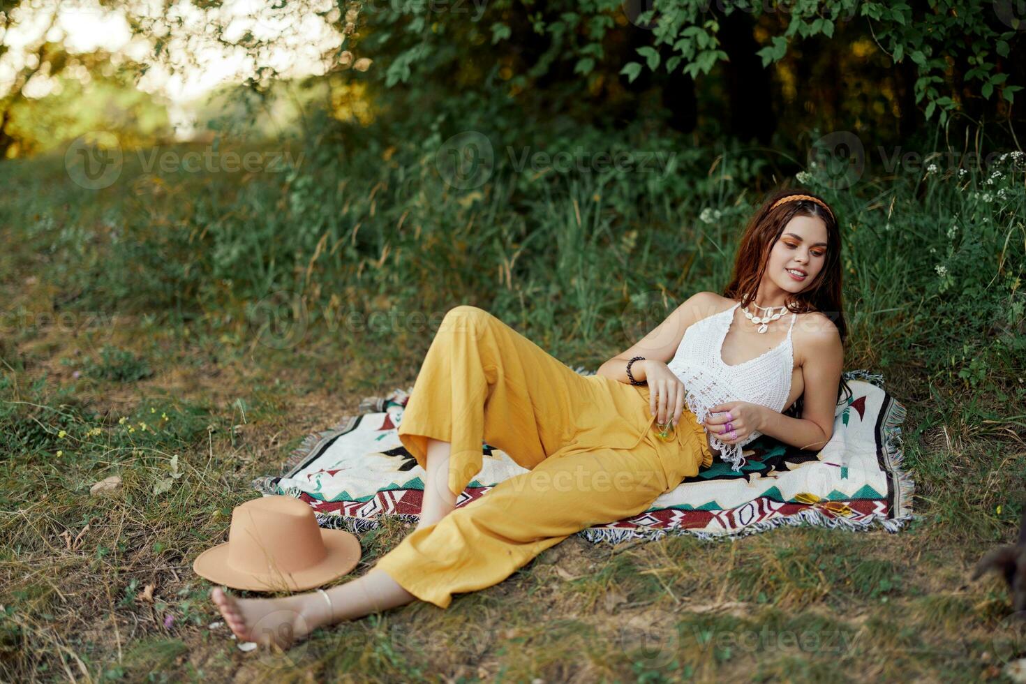 Young Beautiful Hippie Woman Lying On The Ground In Nature In The Fall