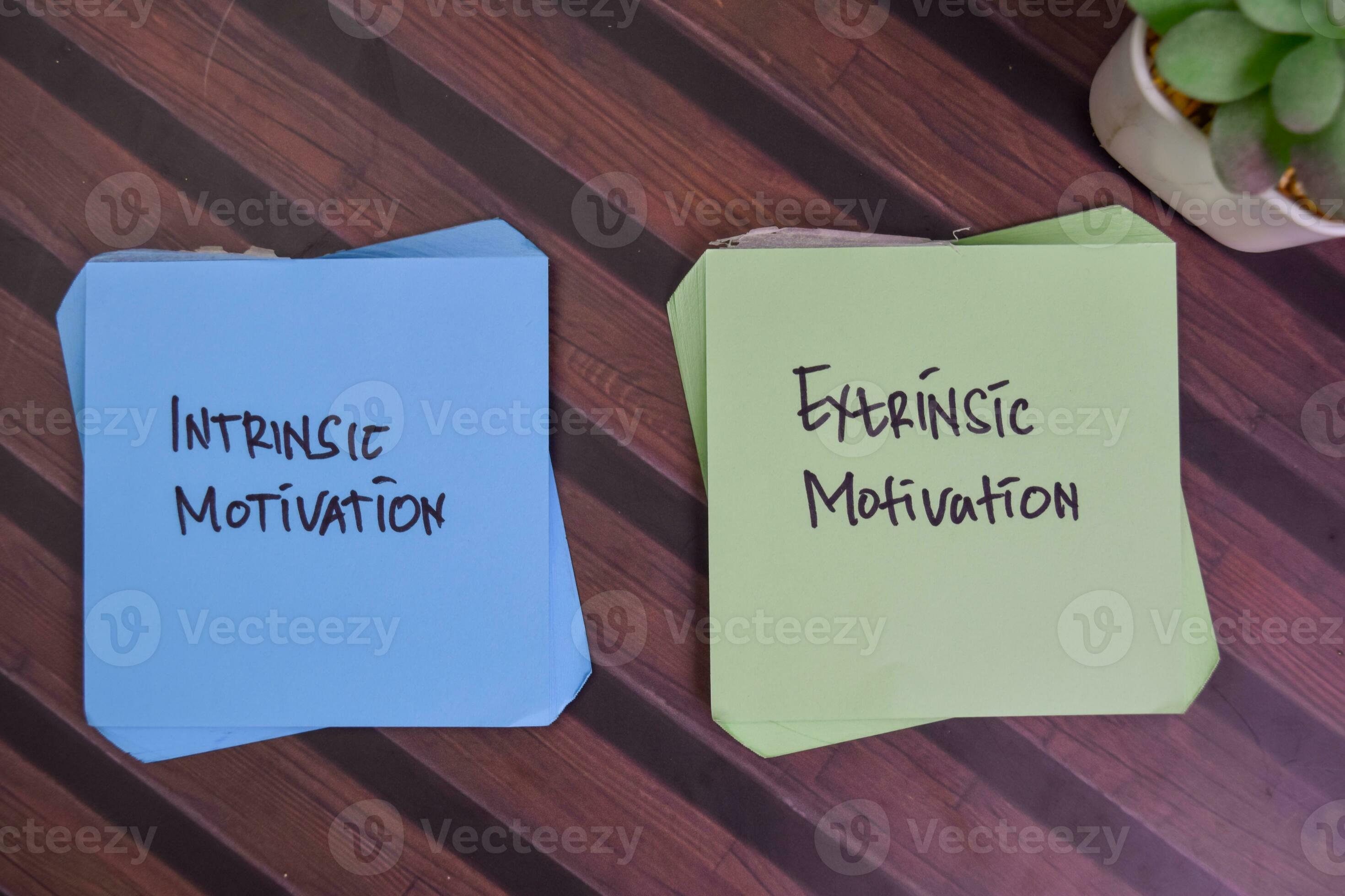 Intrinsic Motivation and Extrinsic Motivation write on sticky notes ...