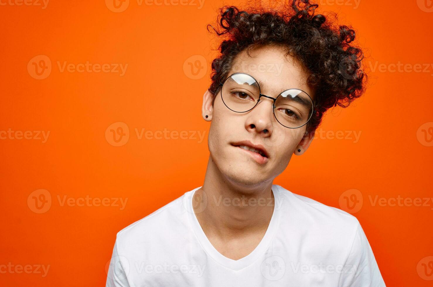 cute guy with curly hair wearing glasses white t-shirt close-up ...