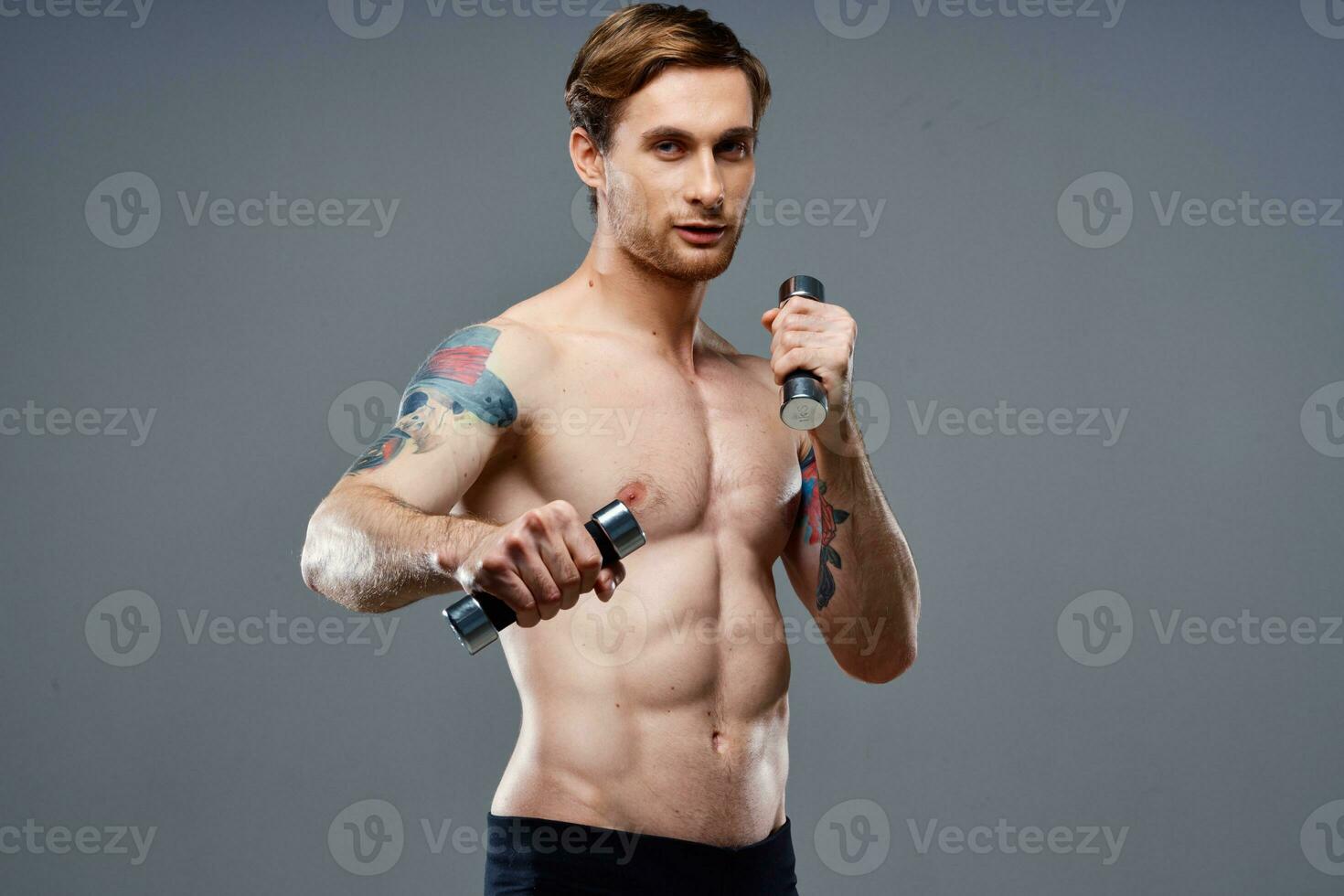 Naked Athlete With A Tattoo And Dumbbells In Hands Phone Fitness