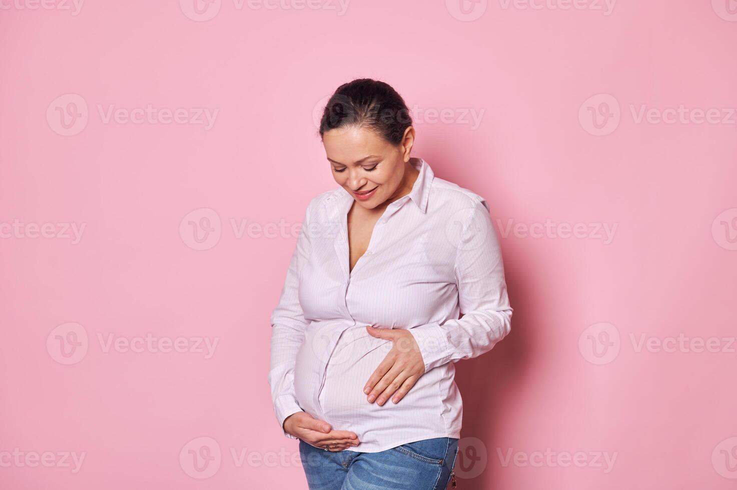 Delightful Happy Pregnant Woman Smiling Cutely While Touching And