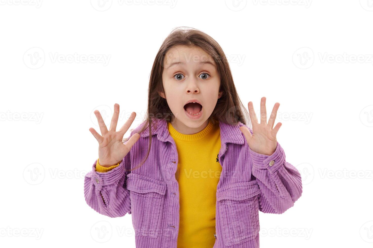 Scared beautiful child girl with afraid look, open mouth and hands palms to camera, screaming ...