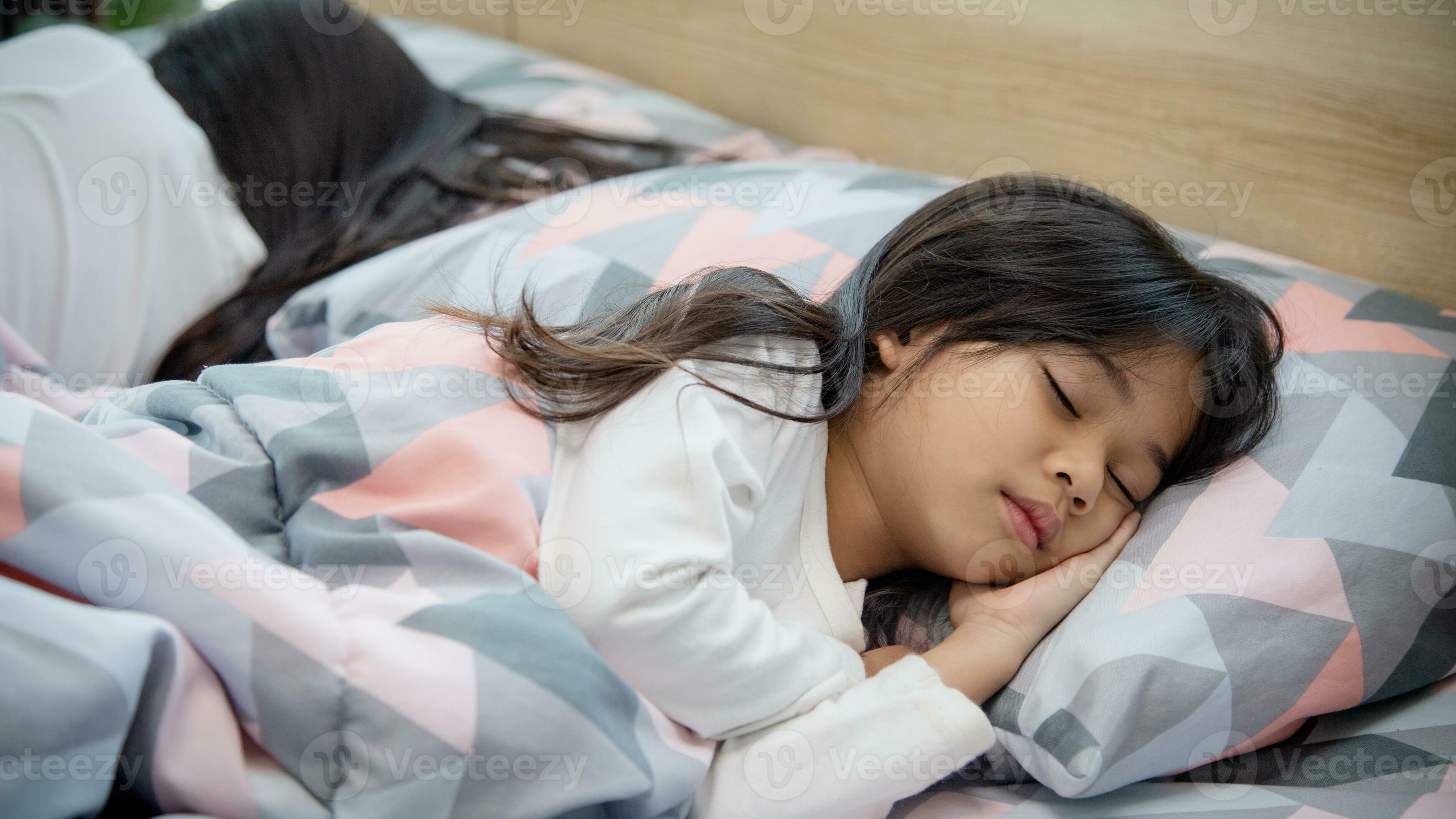 Cute little girl sleeping on bed with soft pillows at home 23740580 ...