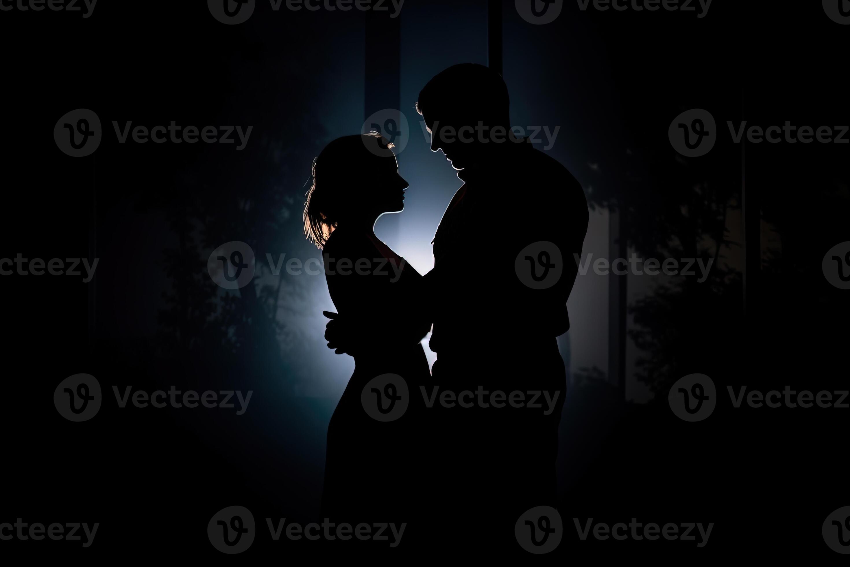 Silhouette of a romantic couple dancing and enjoying in the dark ...