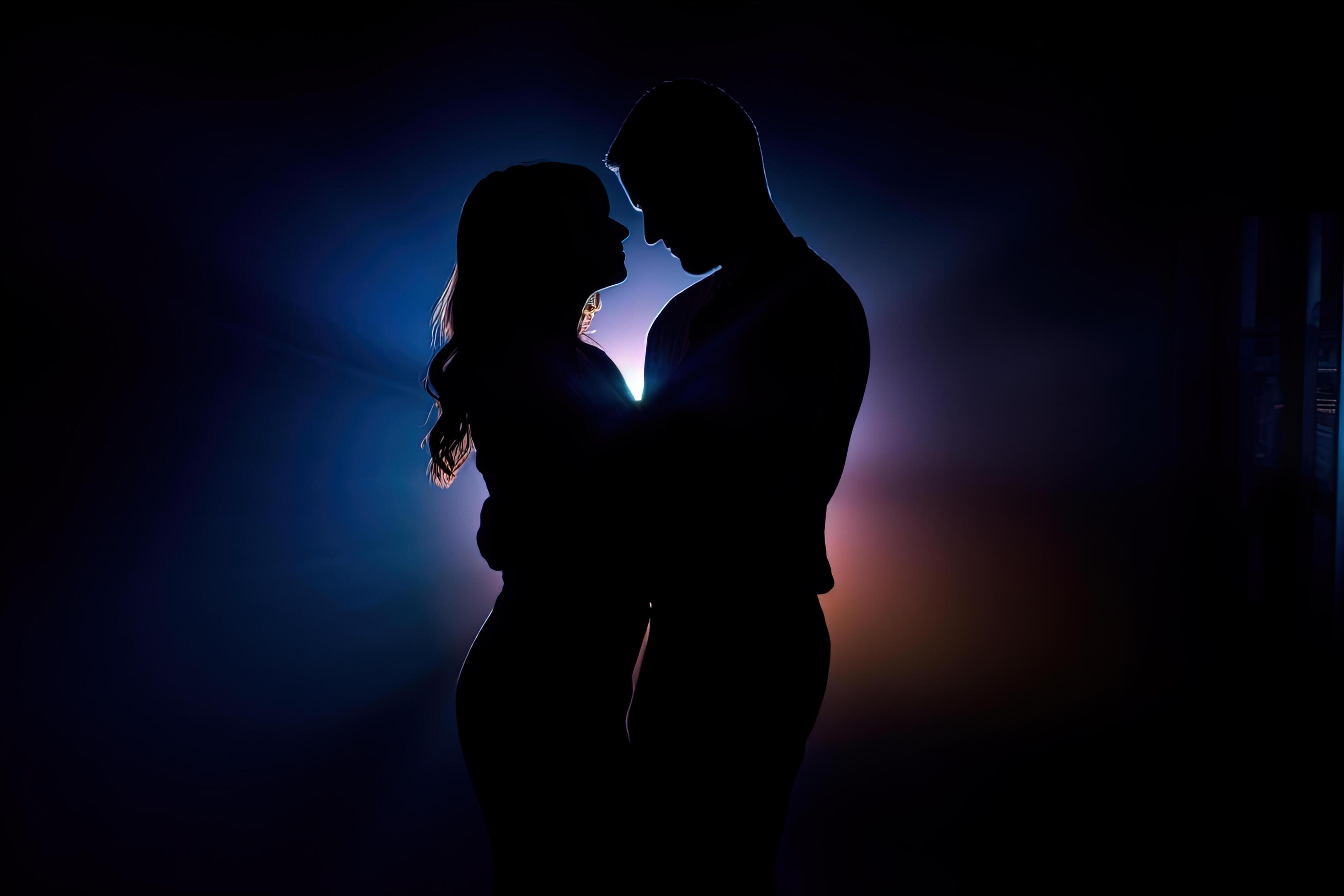 Silhouette of a romantic couple dancing and enjoying in the dark ...