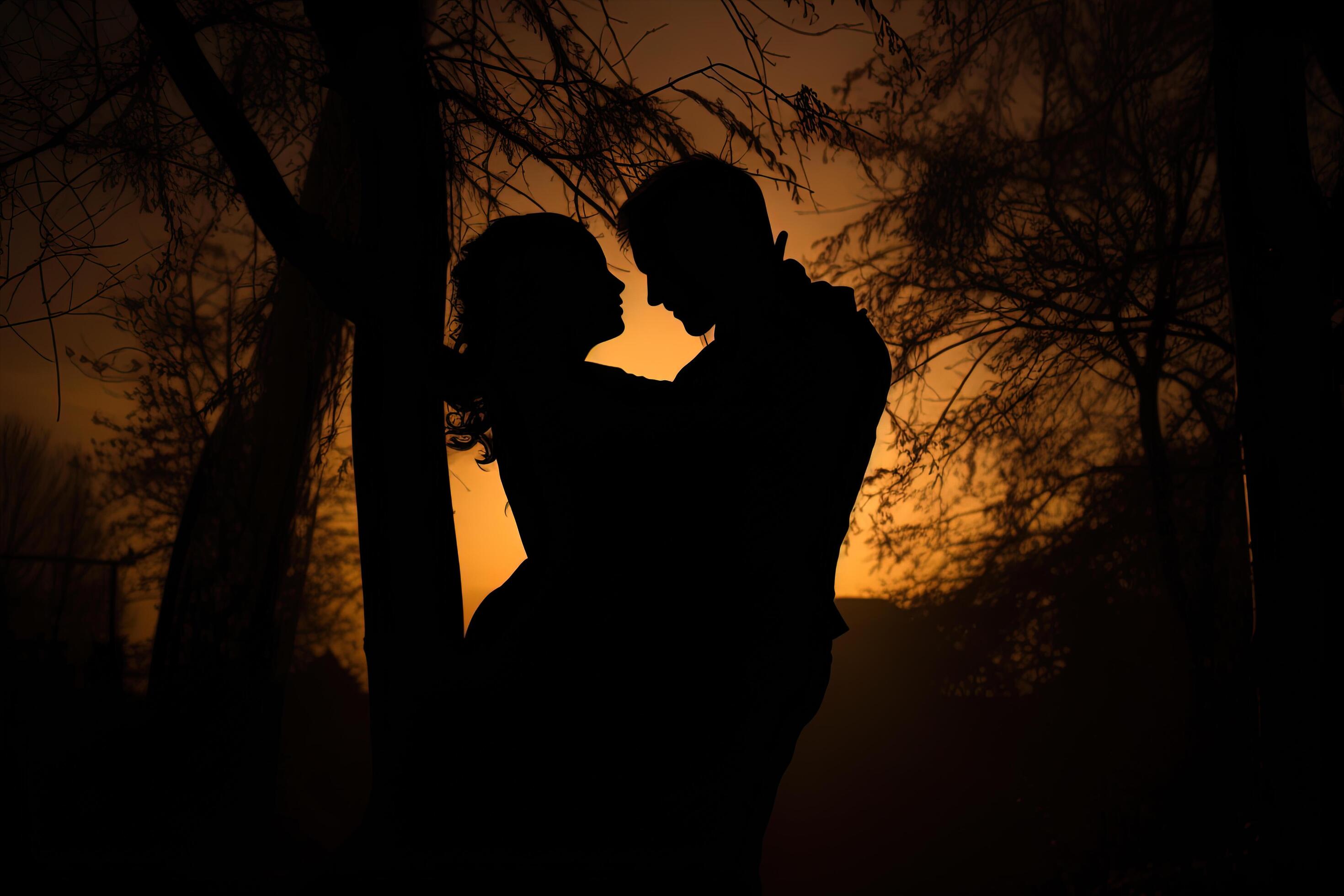 Silhouette of a romantic couple dancing and enjoying in the dark ...