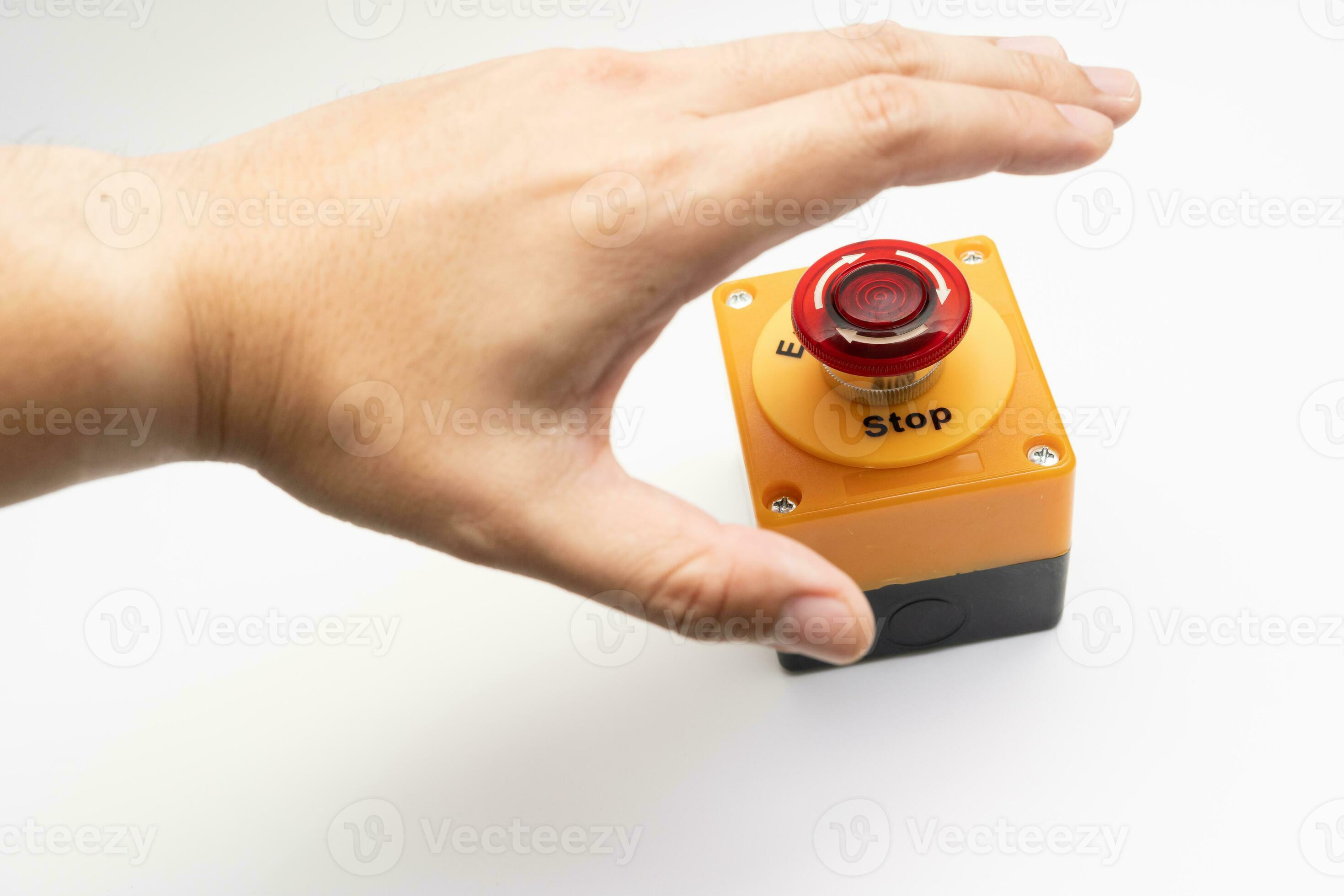 Stop Button and the Hand of Worker About to Press it. emergency stop button. Big Red emergency ...