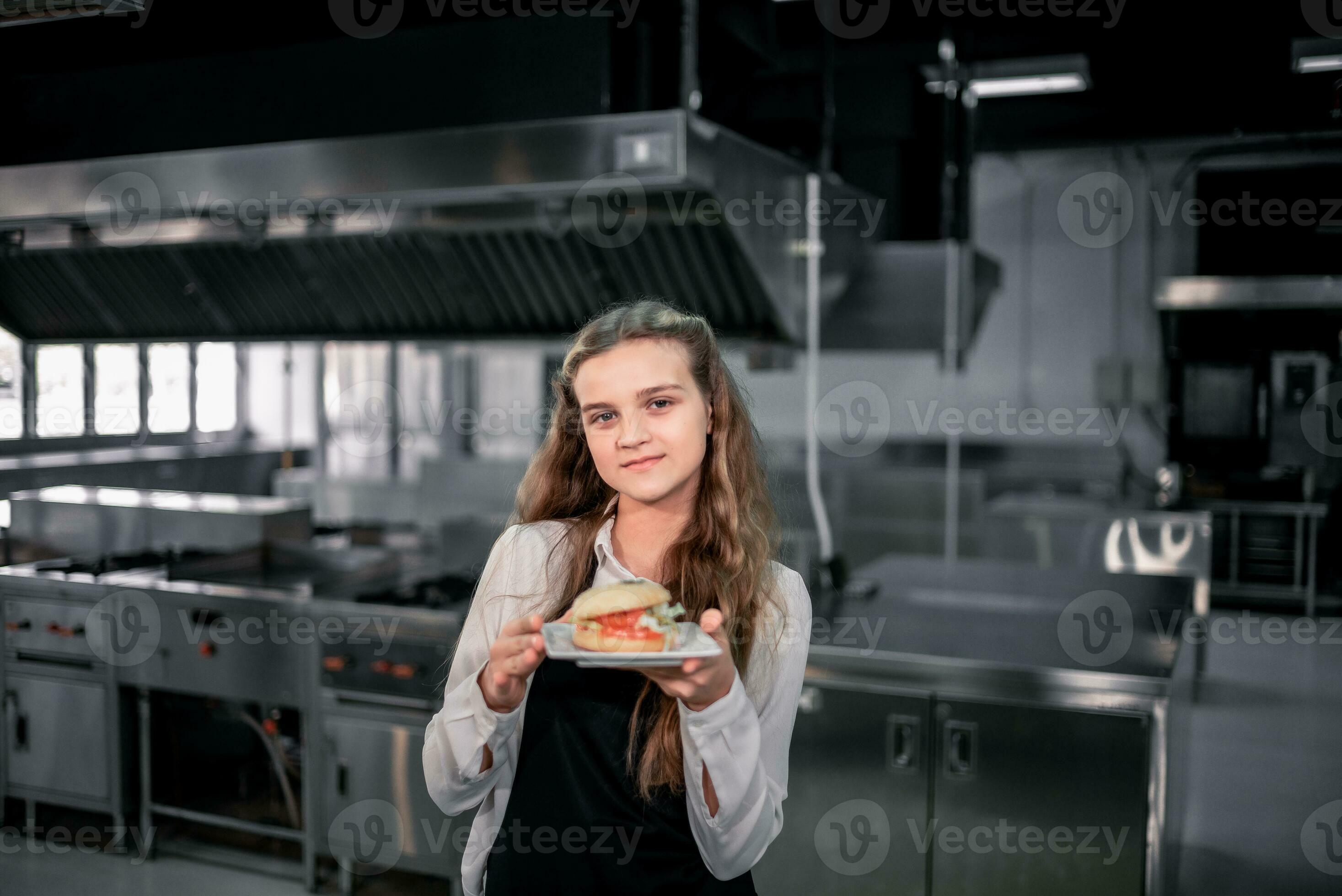 Teenagers learn from expert chefs at culinary school to prepare ingredients and create a variety ...