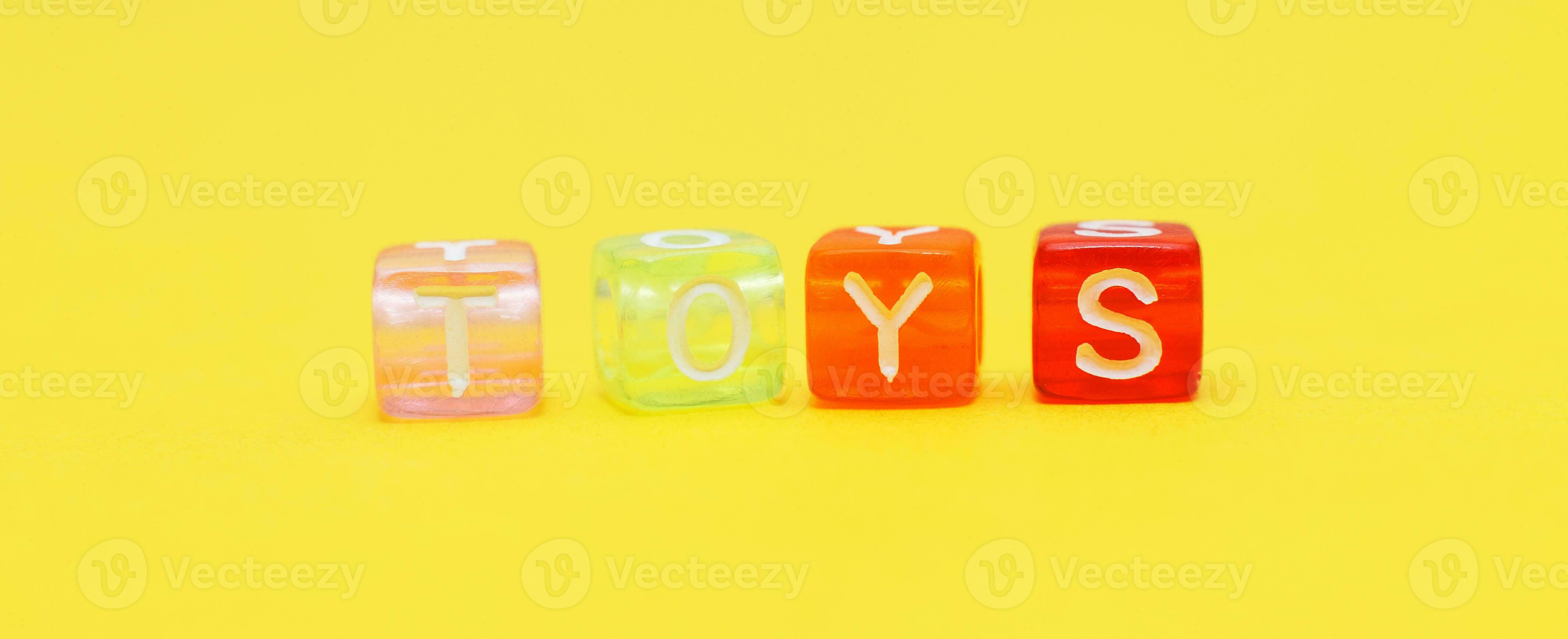Word toys with colorful cubes of beads on yellow. banner 24202007 Stock Photo at Vecteezy