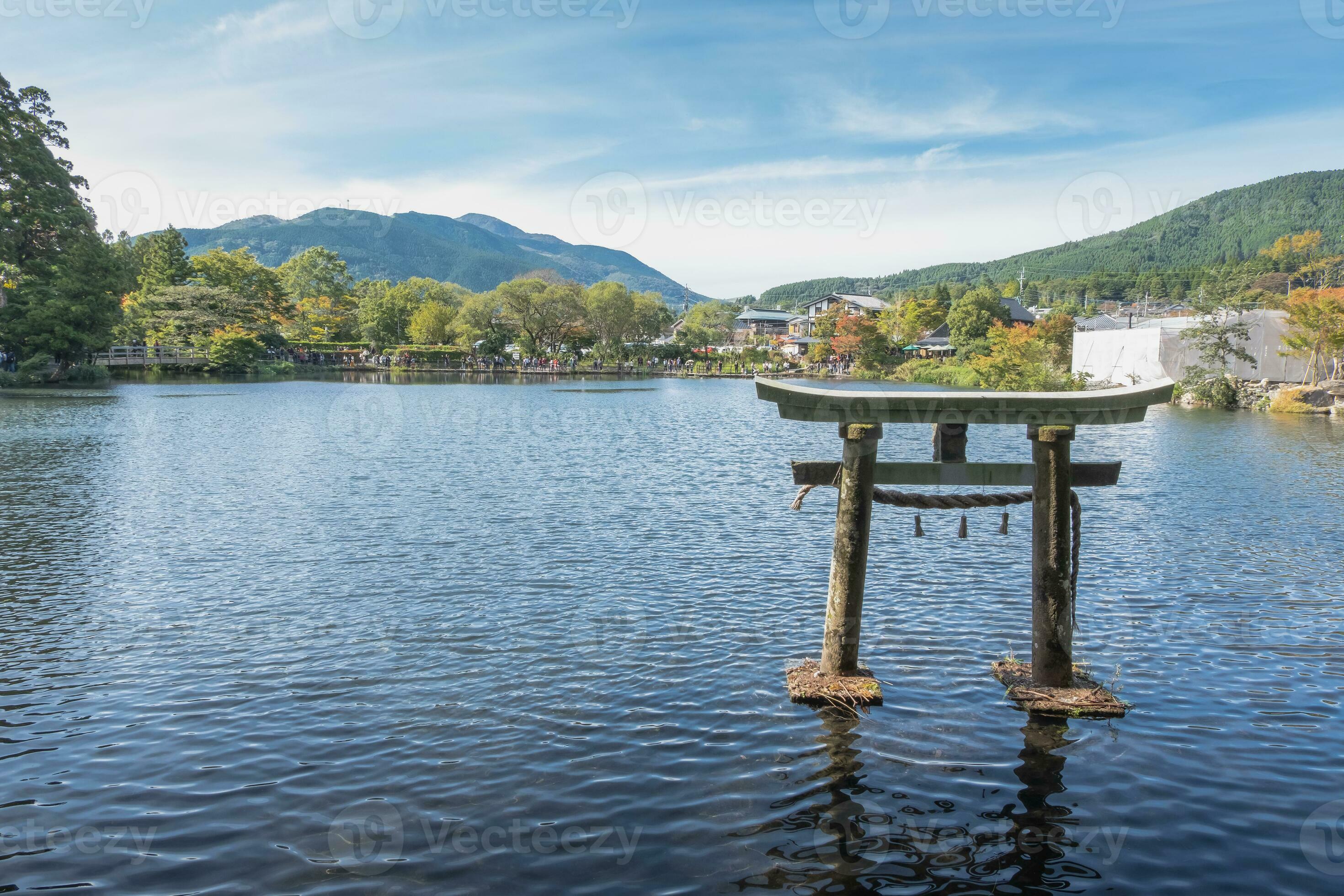 Lake Kinrin and Japanese gate Torii with Mount Yufu and blue sky background at Yufuin, Oita ...