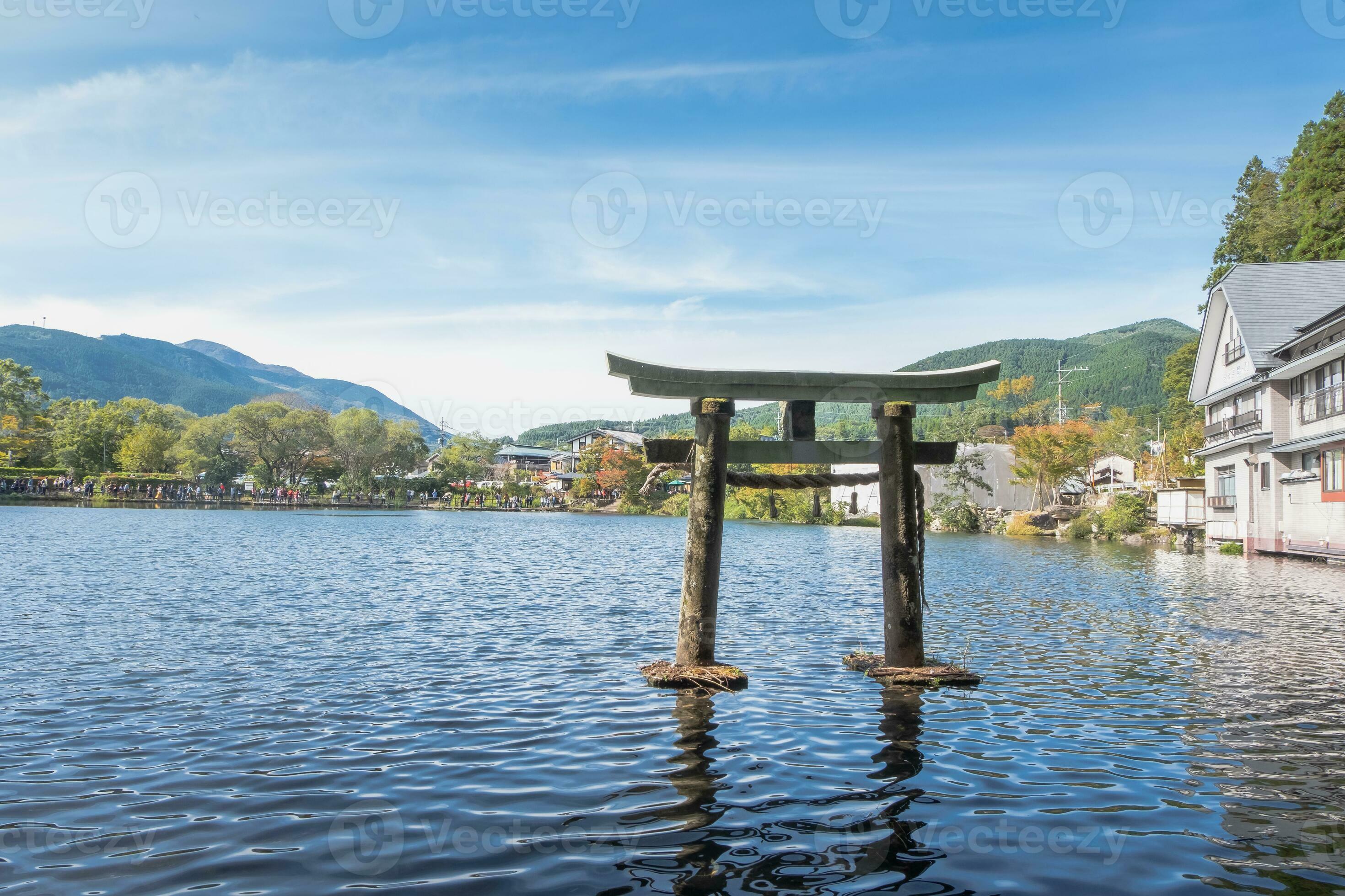 Lake Kinrin and Japanese gate Torii with Mount Yufu and blue sky background at Yufuin, Oita ...