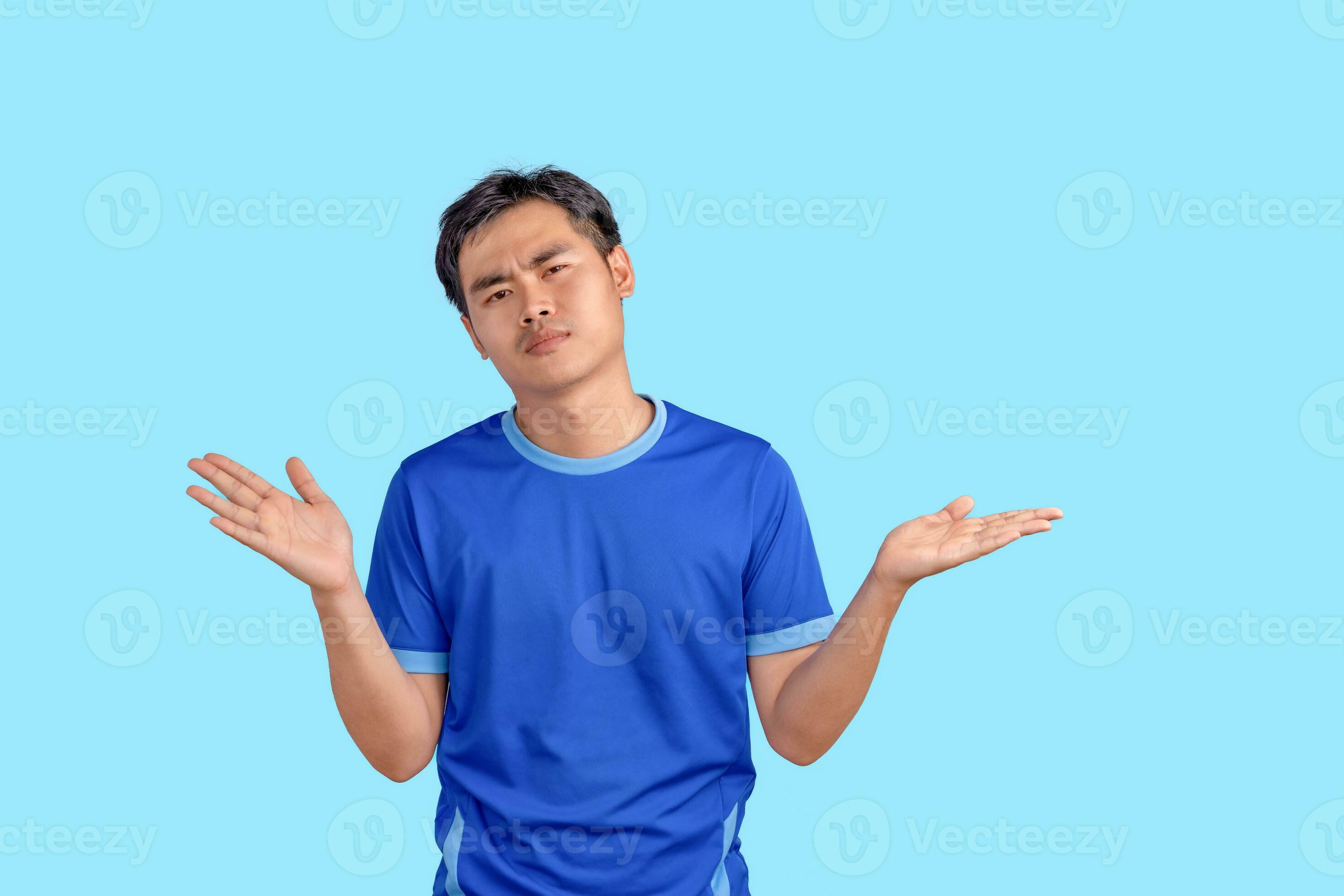 Doubtful Young Man Shrugging With Shoulders Emotional Man On Blue Background I Dont Know Who