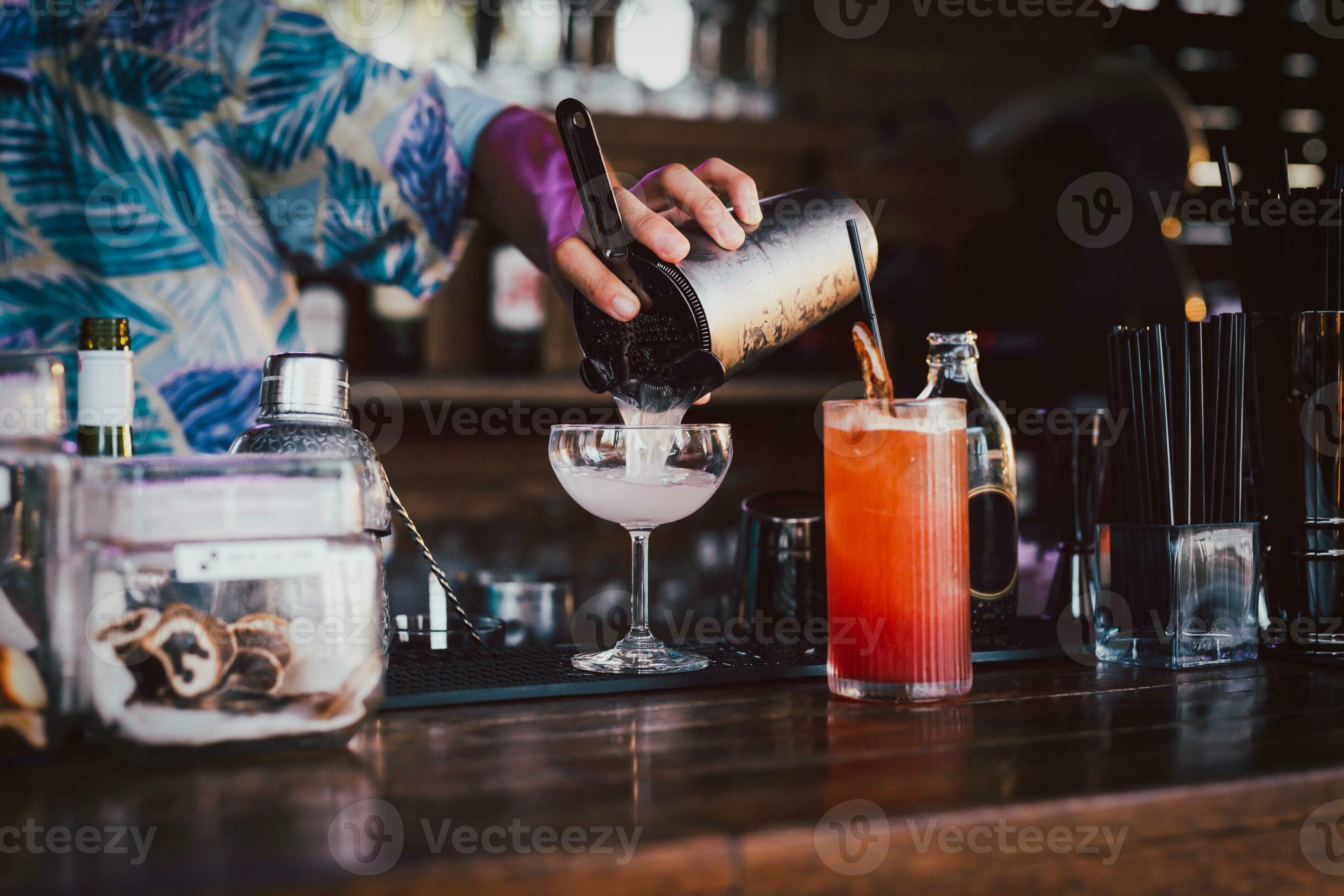 Bartender making cocktail pouring into a martini glass. 24592038 Stock Photo at Vecteezy