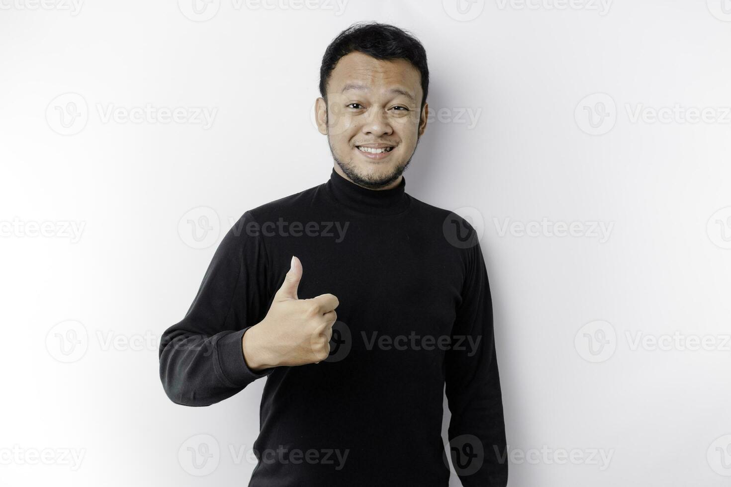 Excited Asian man wearing black shirt gives thumbs up hand gesture of ...