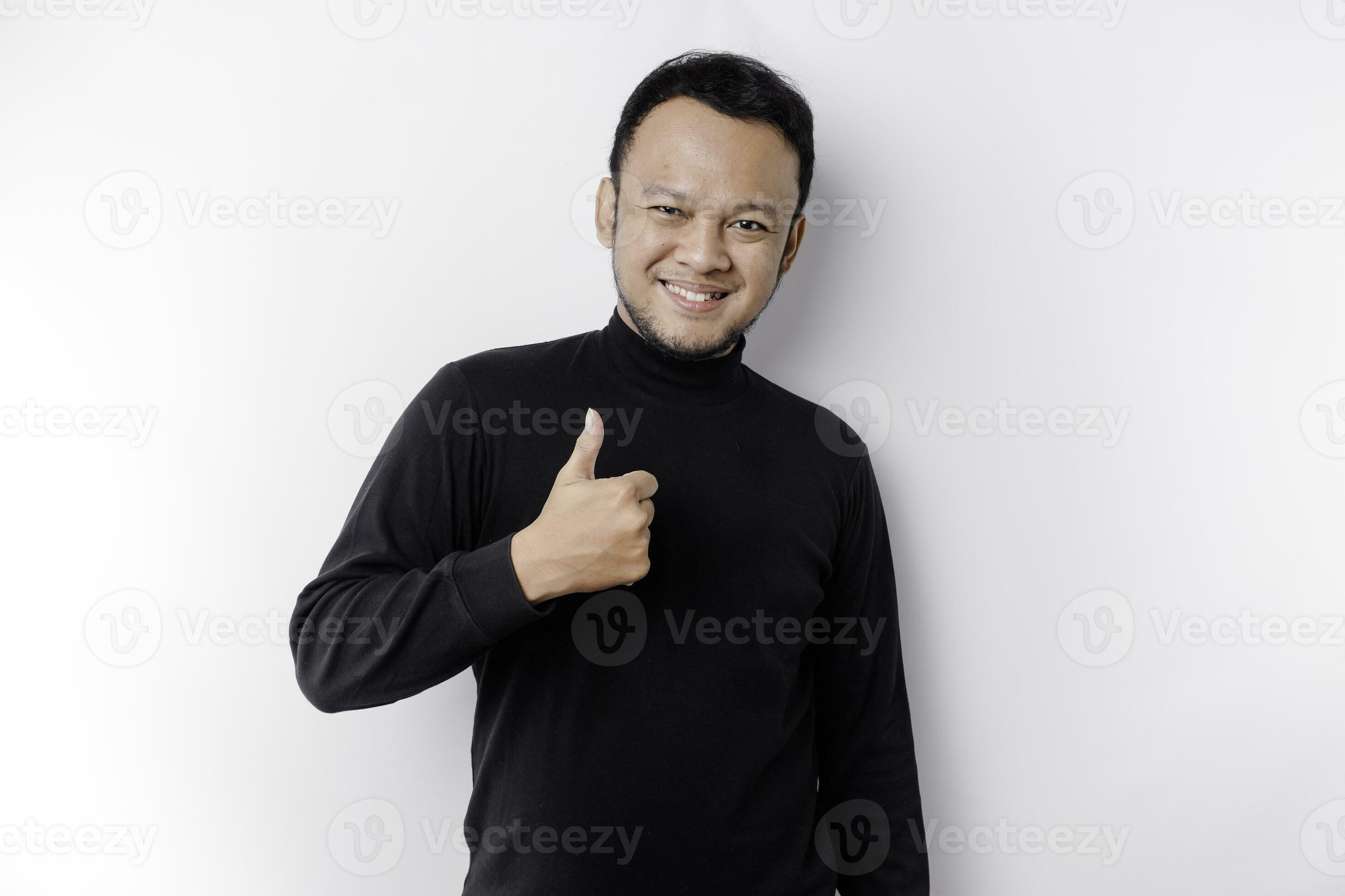 Excited Asian man wearing black shirt gives thumbs up hand gesture of ...