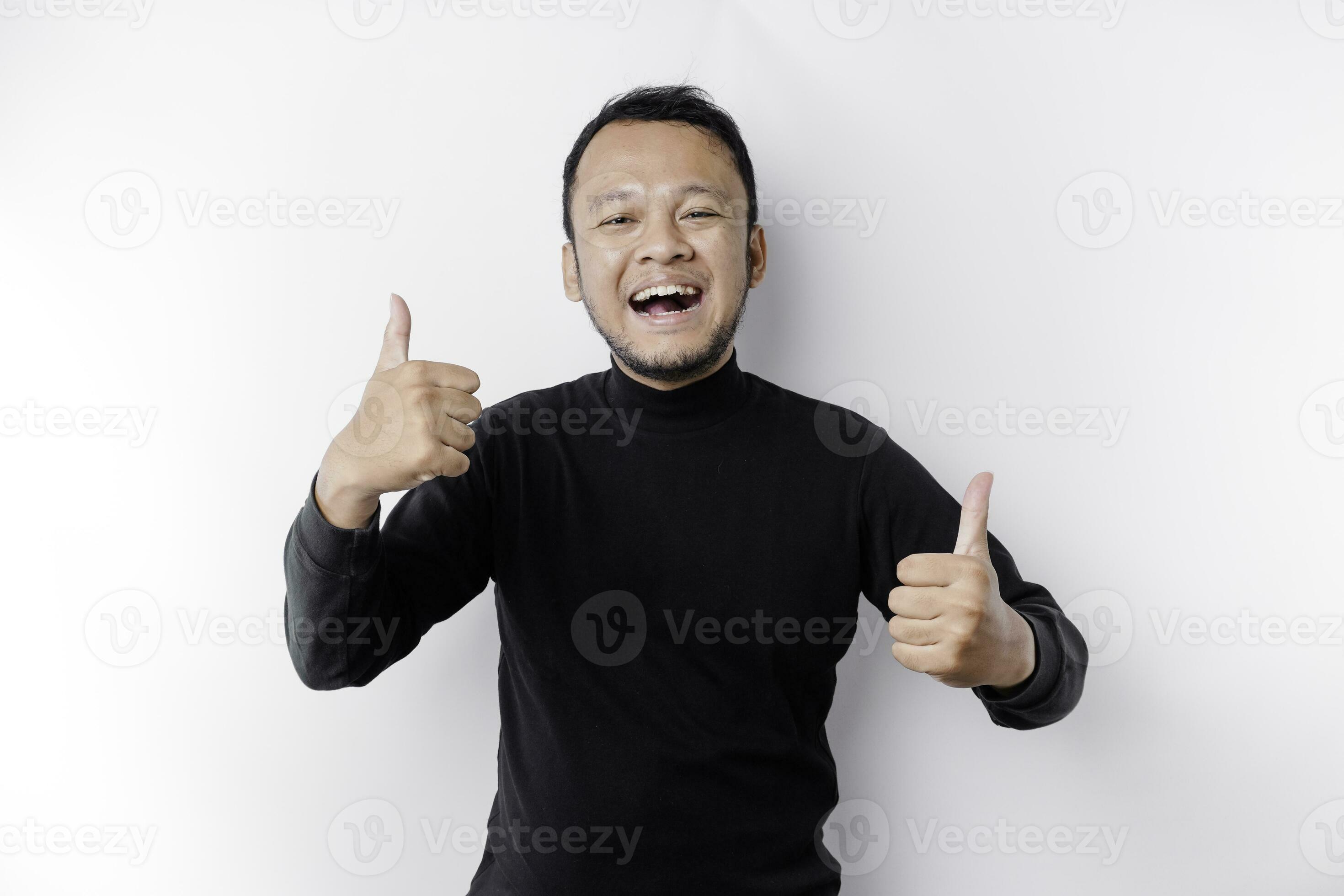 Excited Asian man wearing black shirt gives thumbs up hand gesture of ...