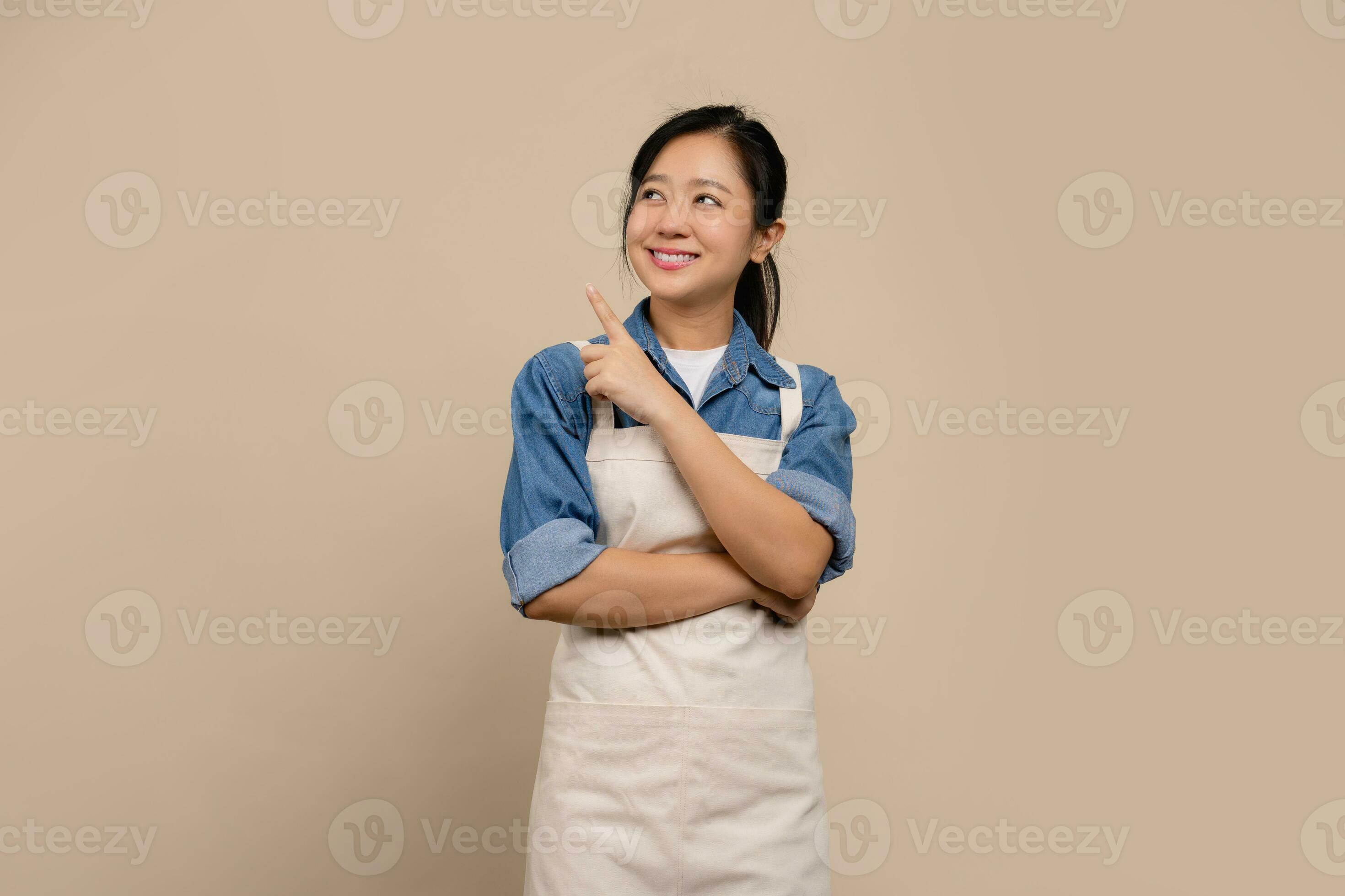 Cheerful smiling asian female barista wear cream color apron, She is ...