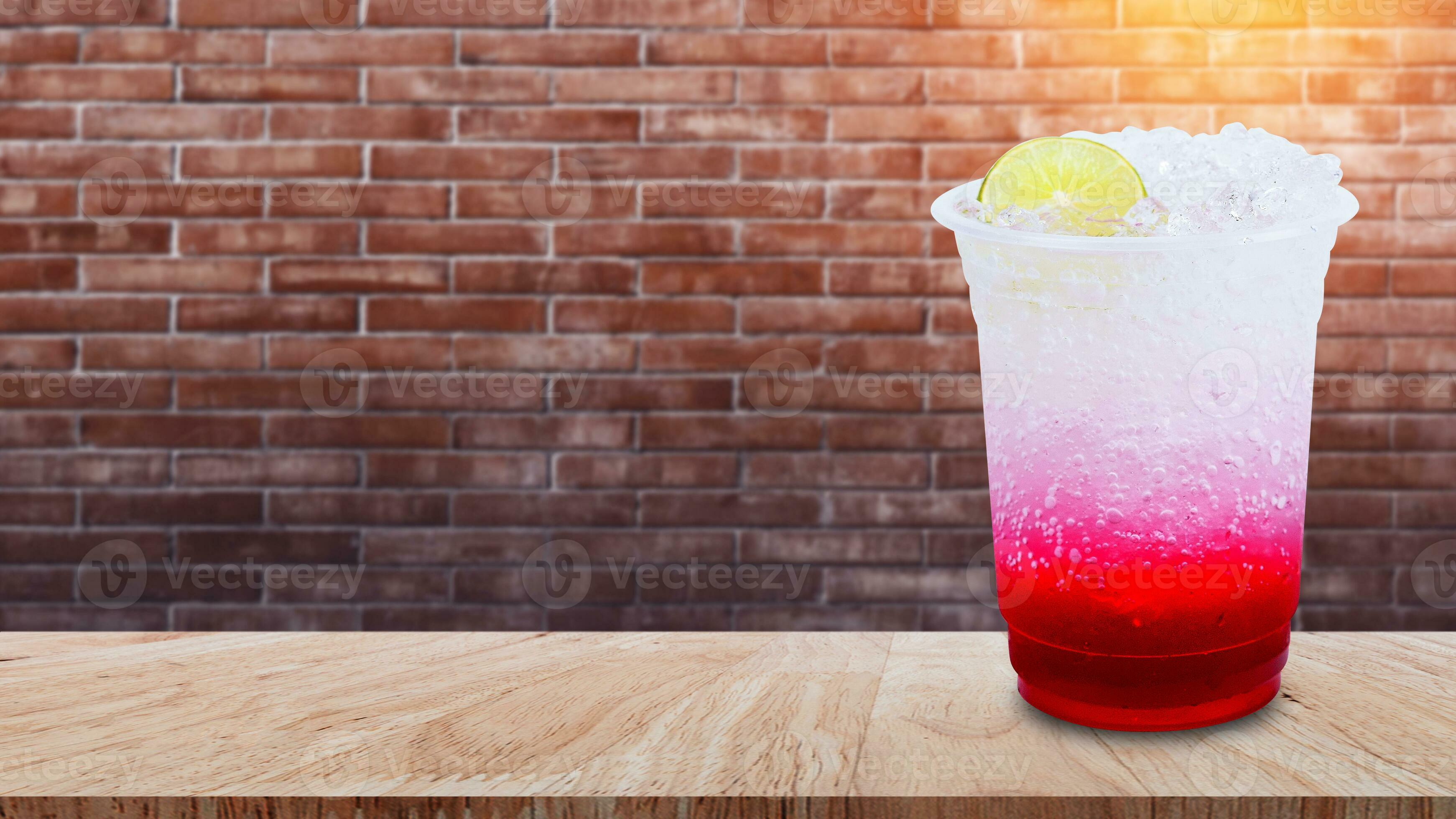 Italian Soda Made From Fruit Syrup Drink Mix In Plastic Cup On Wooden Table Lemon Red Cocktail