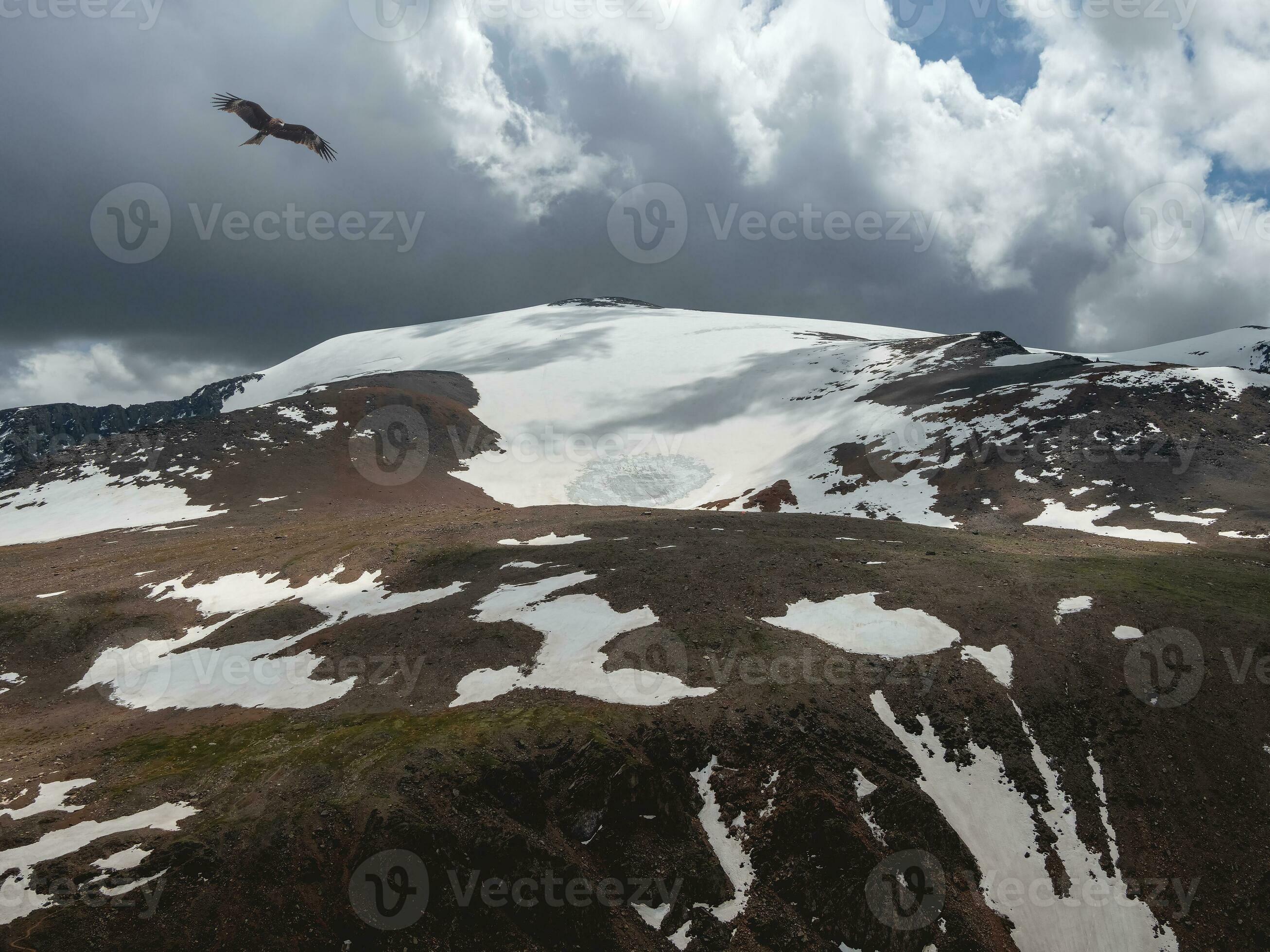 Bright atmospheric scenery on top of spotted snow mountain ridge under ...