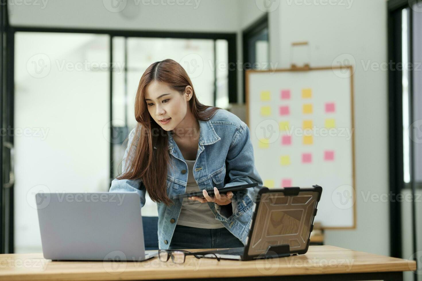 Young female programmer working on laptops. 24770857 Stock Photo at ...