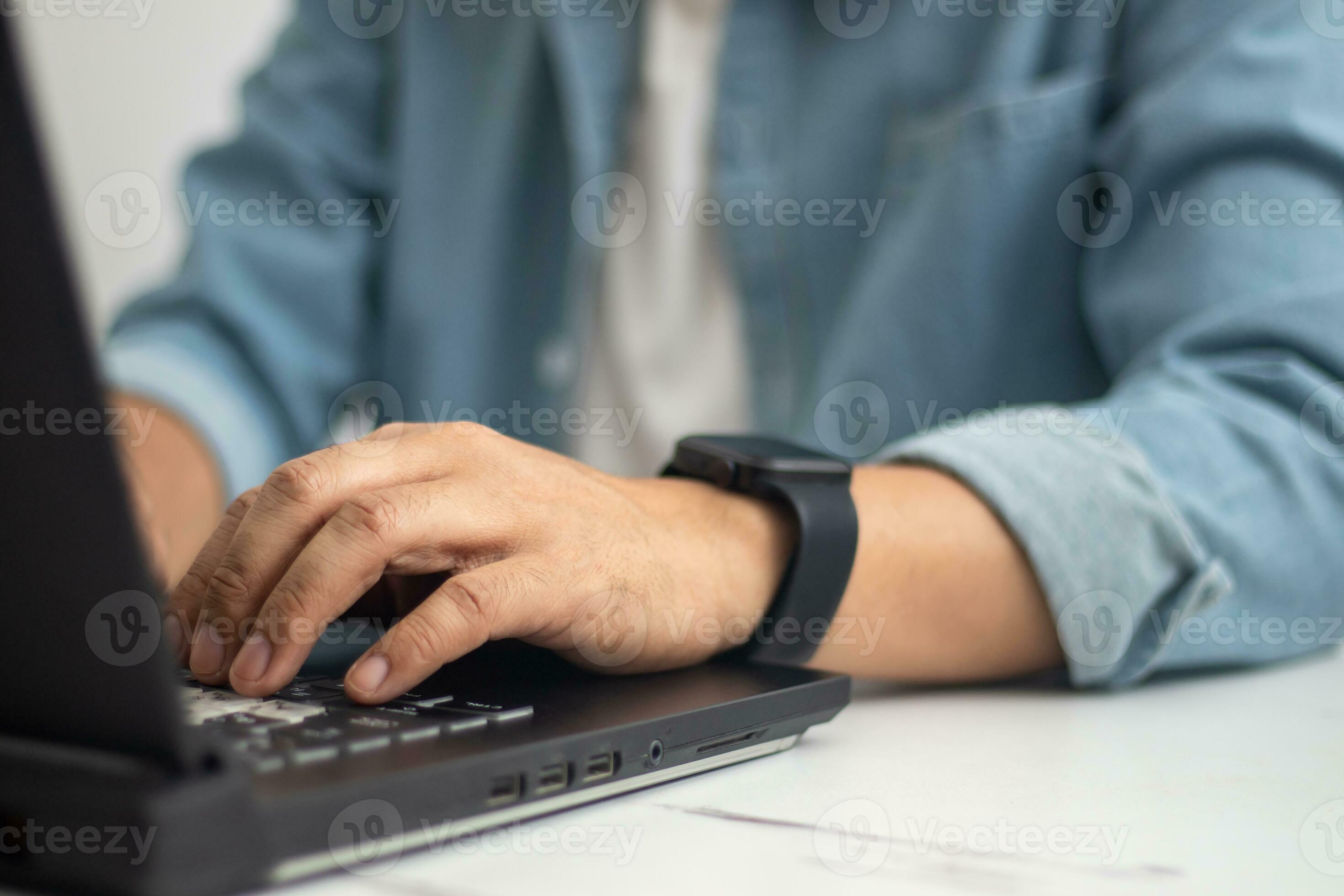 Male Hands Typing On Laptop Keyboard And Surfing Internet On Desk Business Concept And