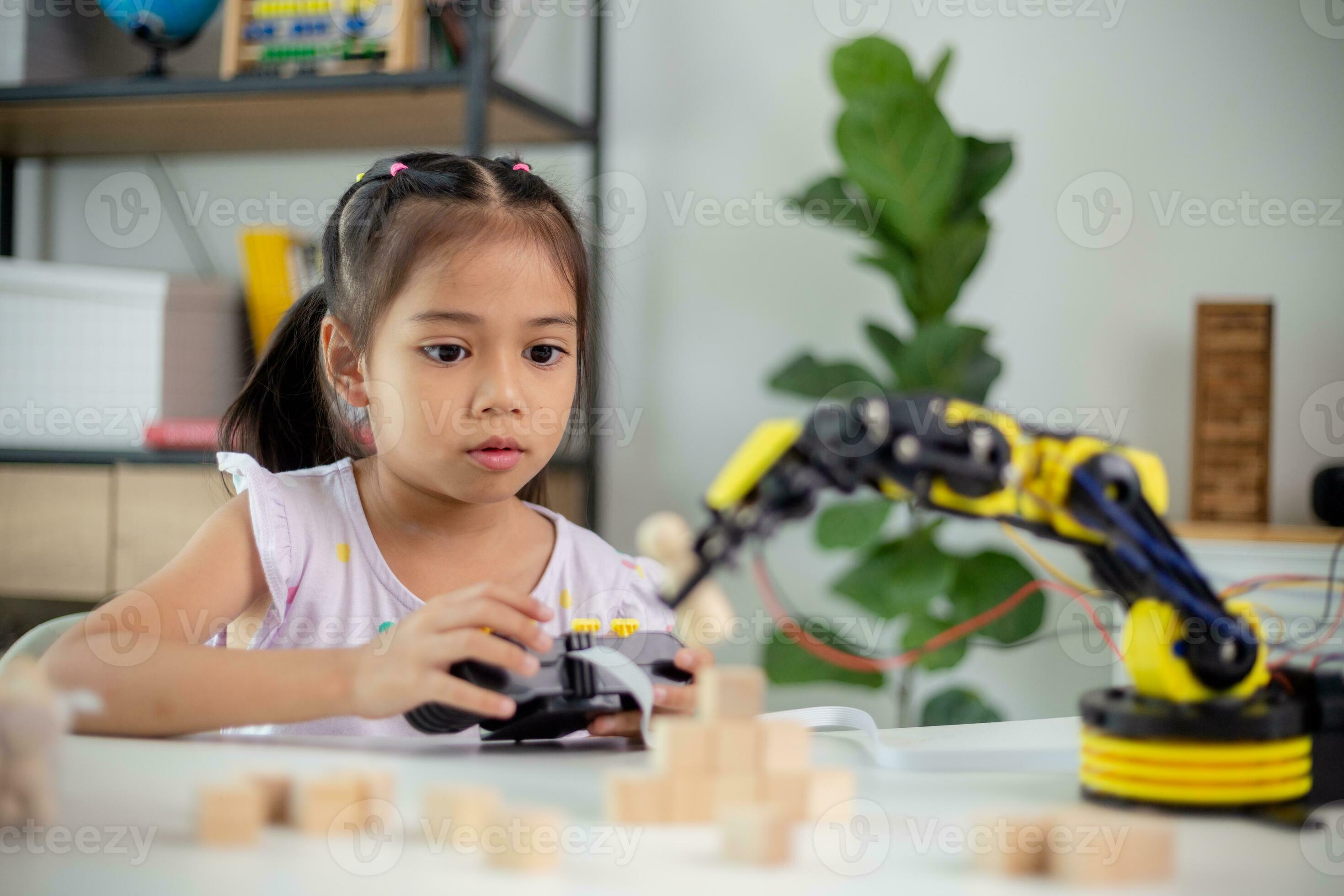 STEM education concept. Asian students learn at home by coding robot arms in STEM, mathematics ...